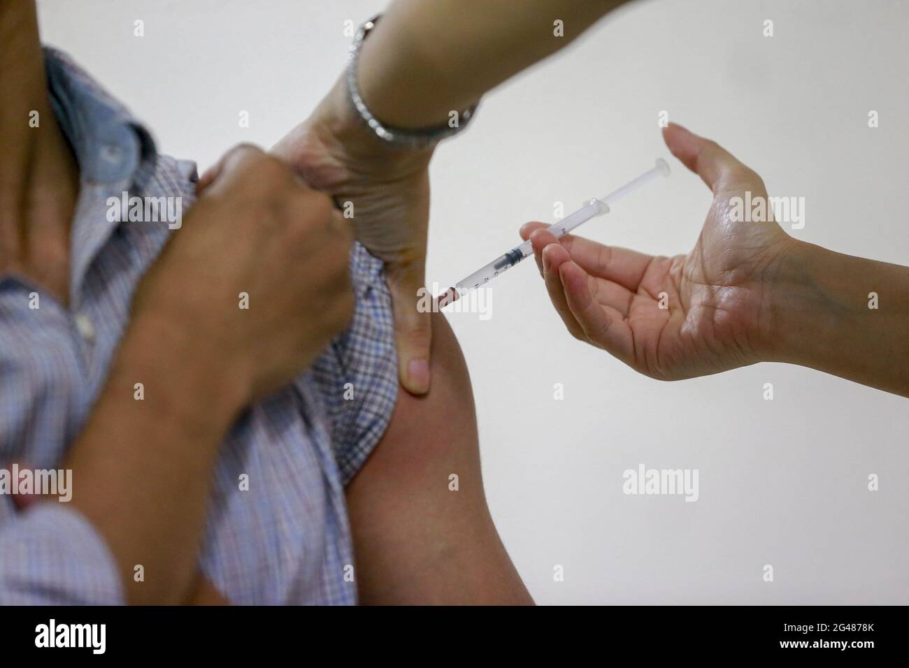A medical student receives a dose of the Sinopharma coronavirus vaccine ...