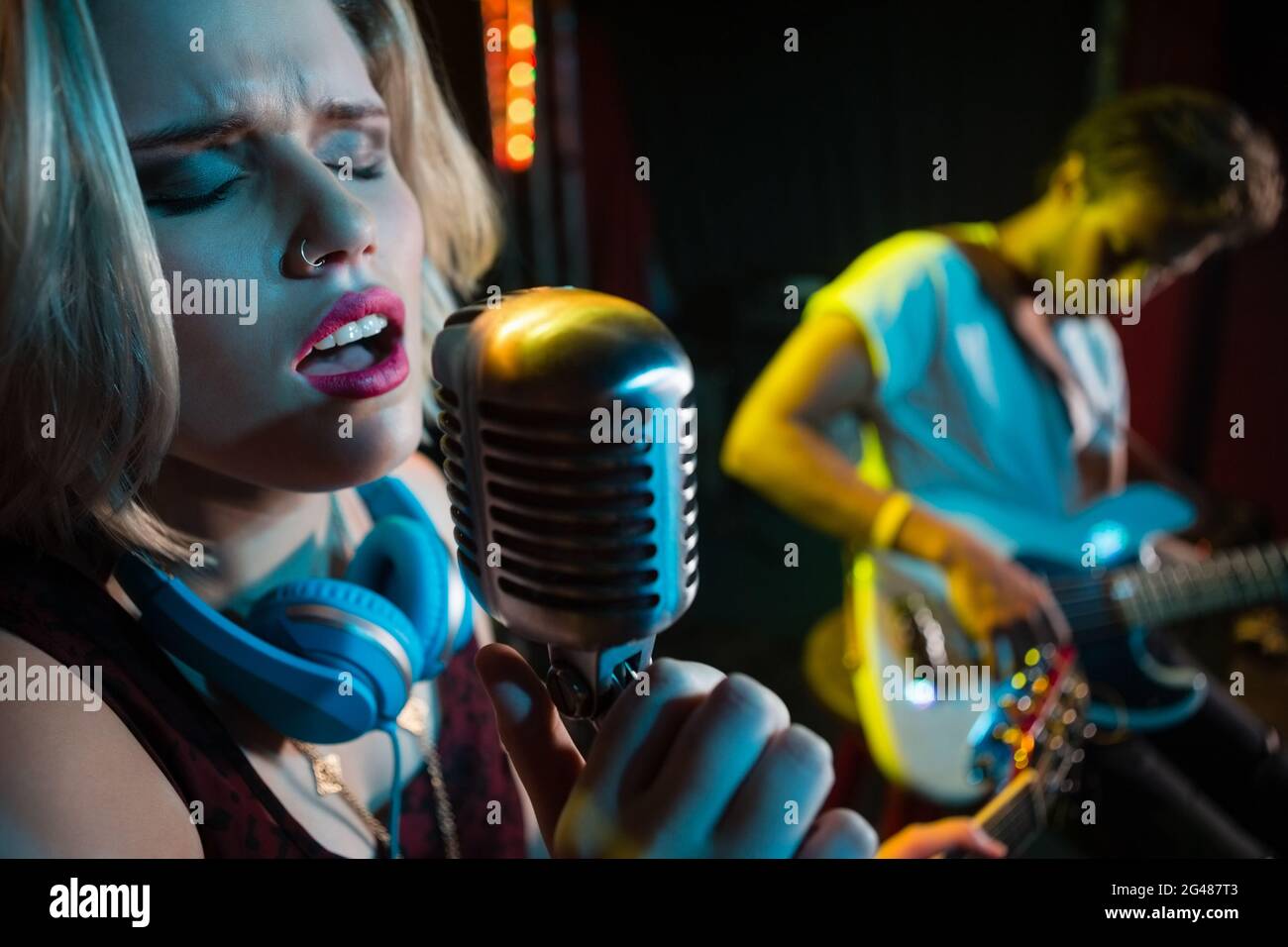 Female singer singing on vintage microphone Stock Photo - Alamy