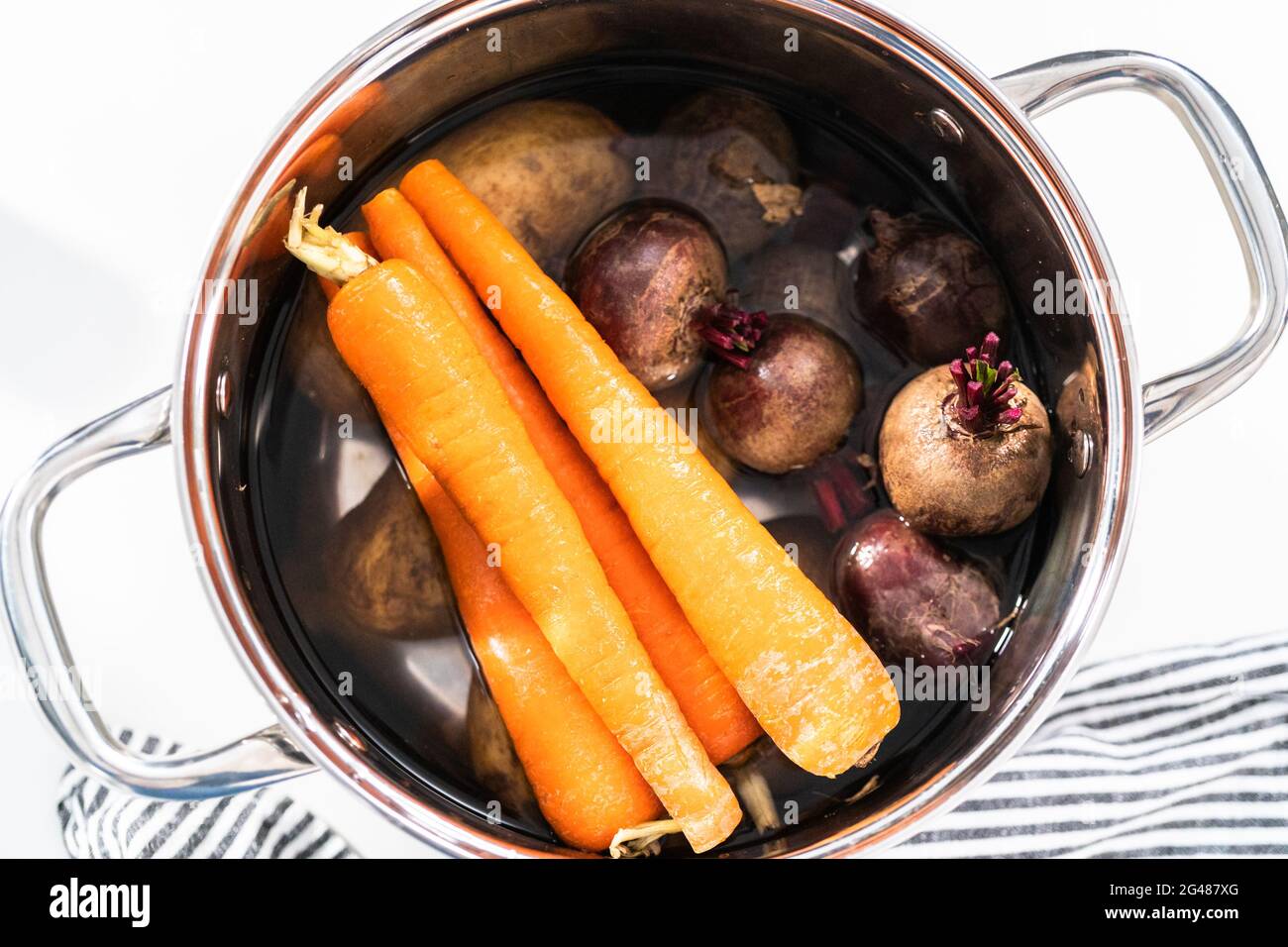 Boiling vegetables in a big cooking pot to make a vinaigrette salad ...