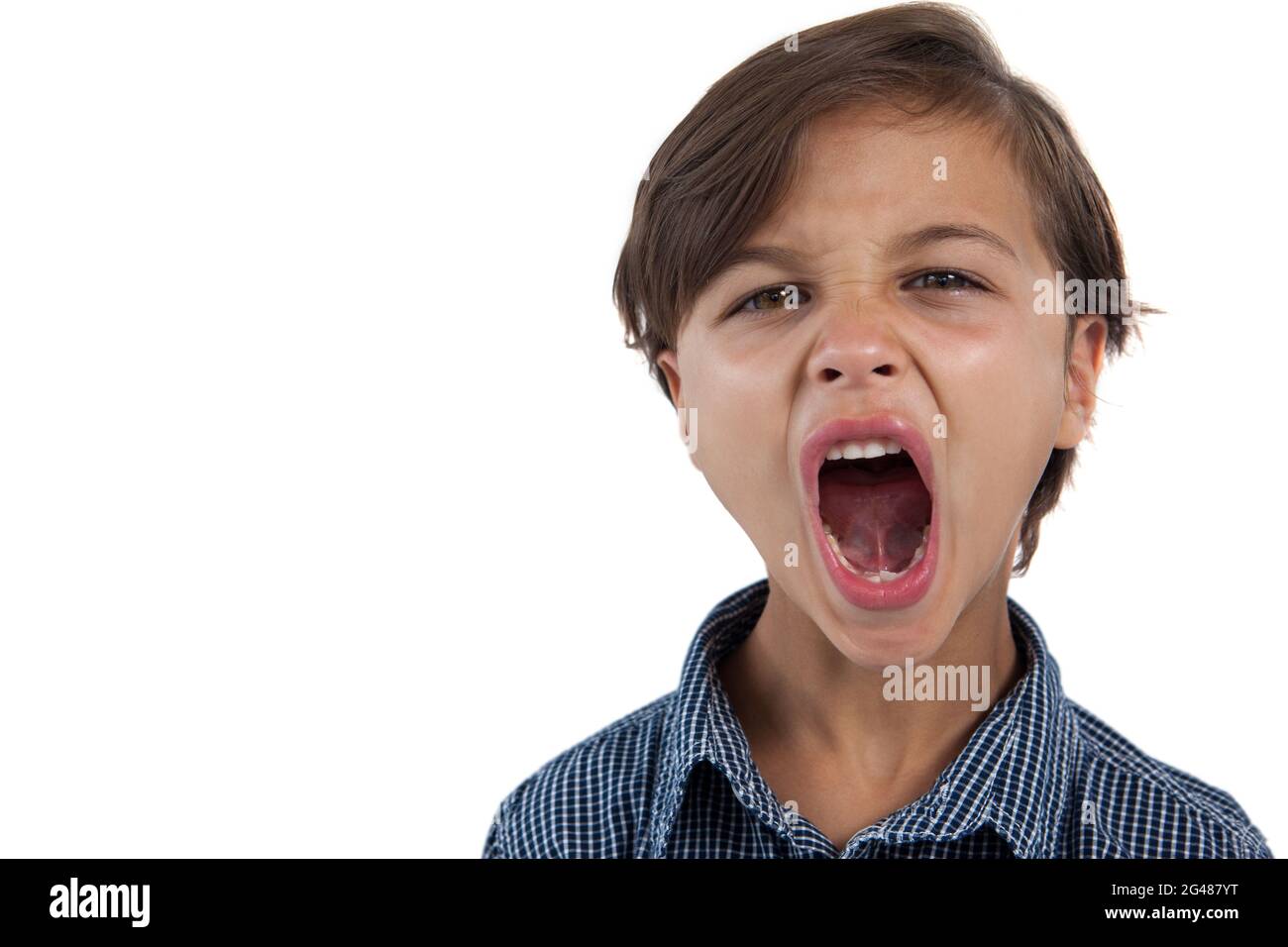 Boy shouting against white background Stock Photo - Alamy