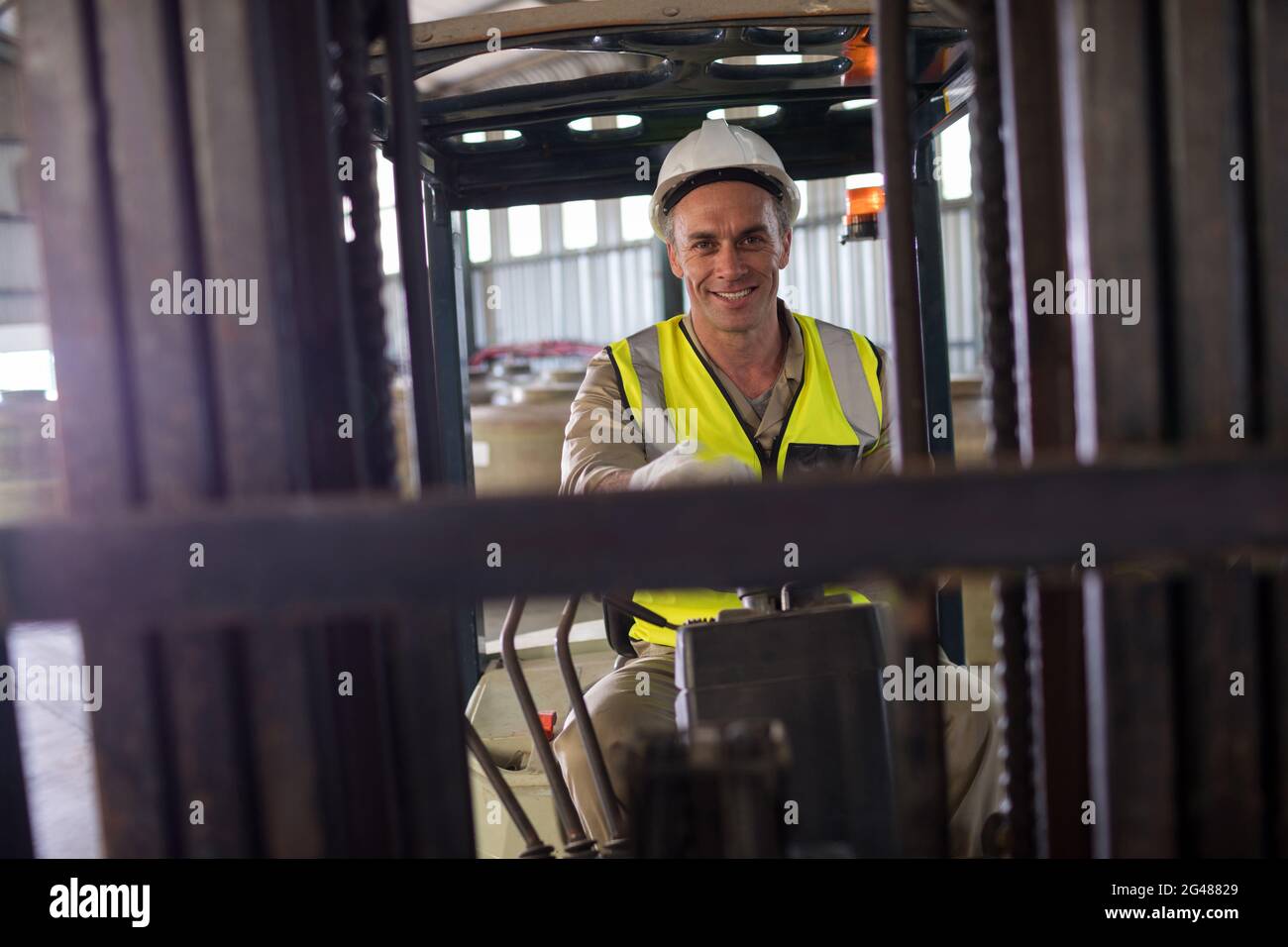 Portrait of worker driving forklift Stock Photo - Alamy