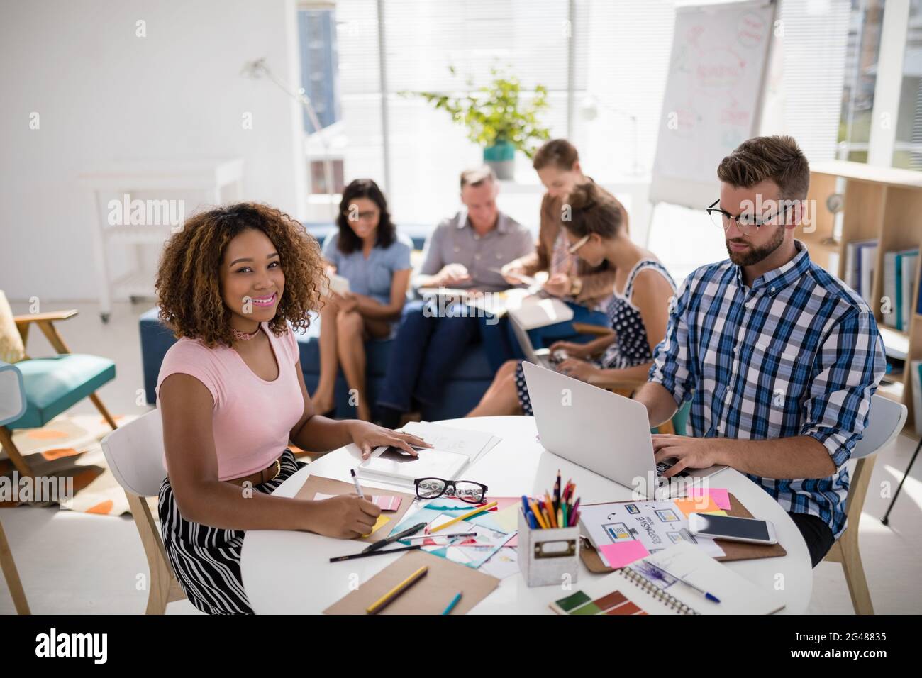 Group executives sitting working together hi-res stock photography and ...