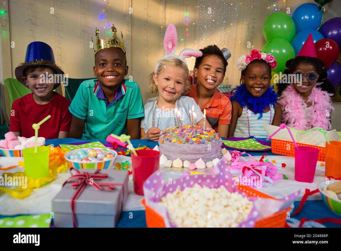 Smiling sitting bonding childhood celebration party hat hi-res stock ...