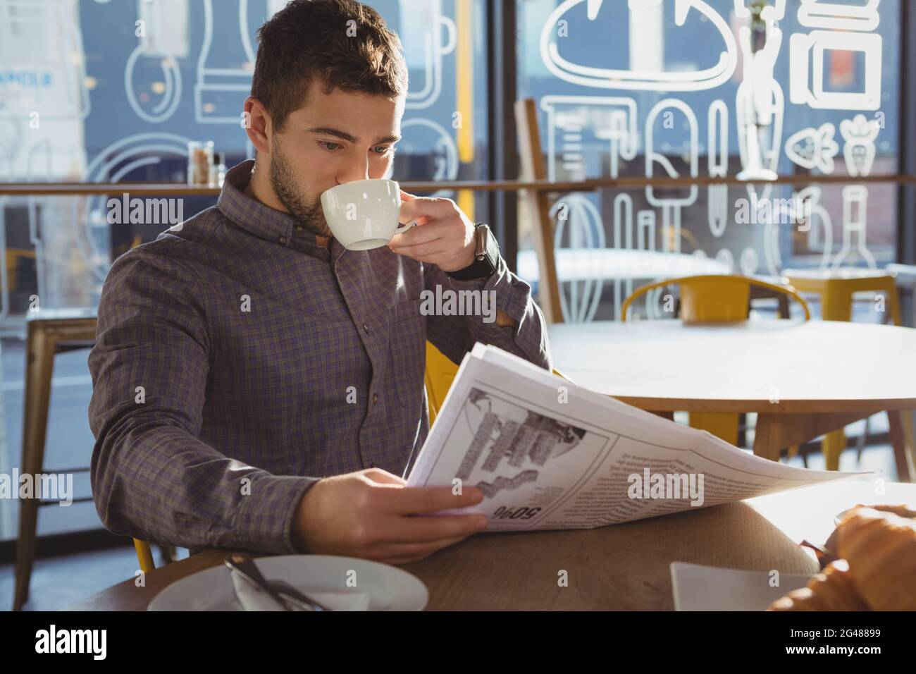 Businessman in cafe holding newspaper hi-res stock photography and ...