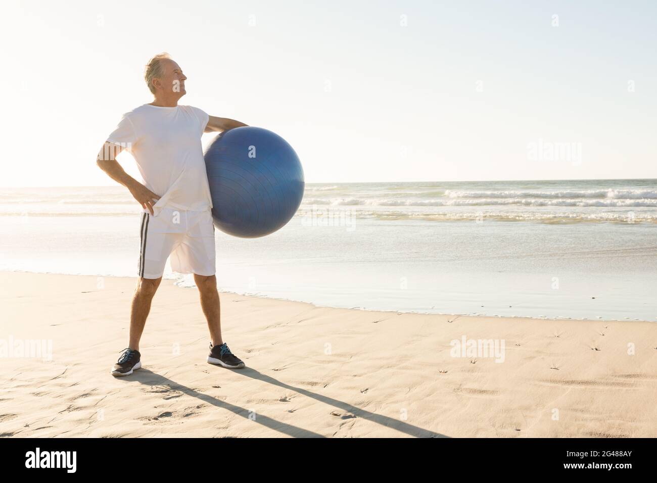 Standing holding looking away smiling hand raised hi-res stock ...