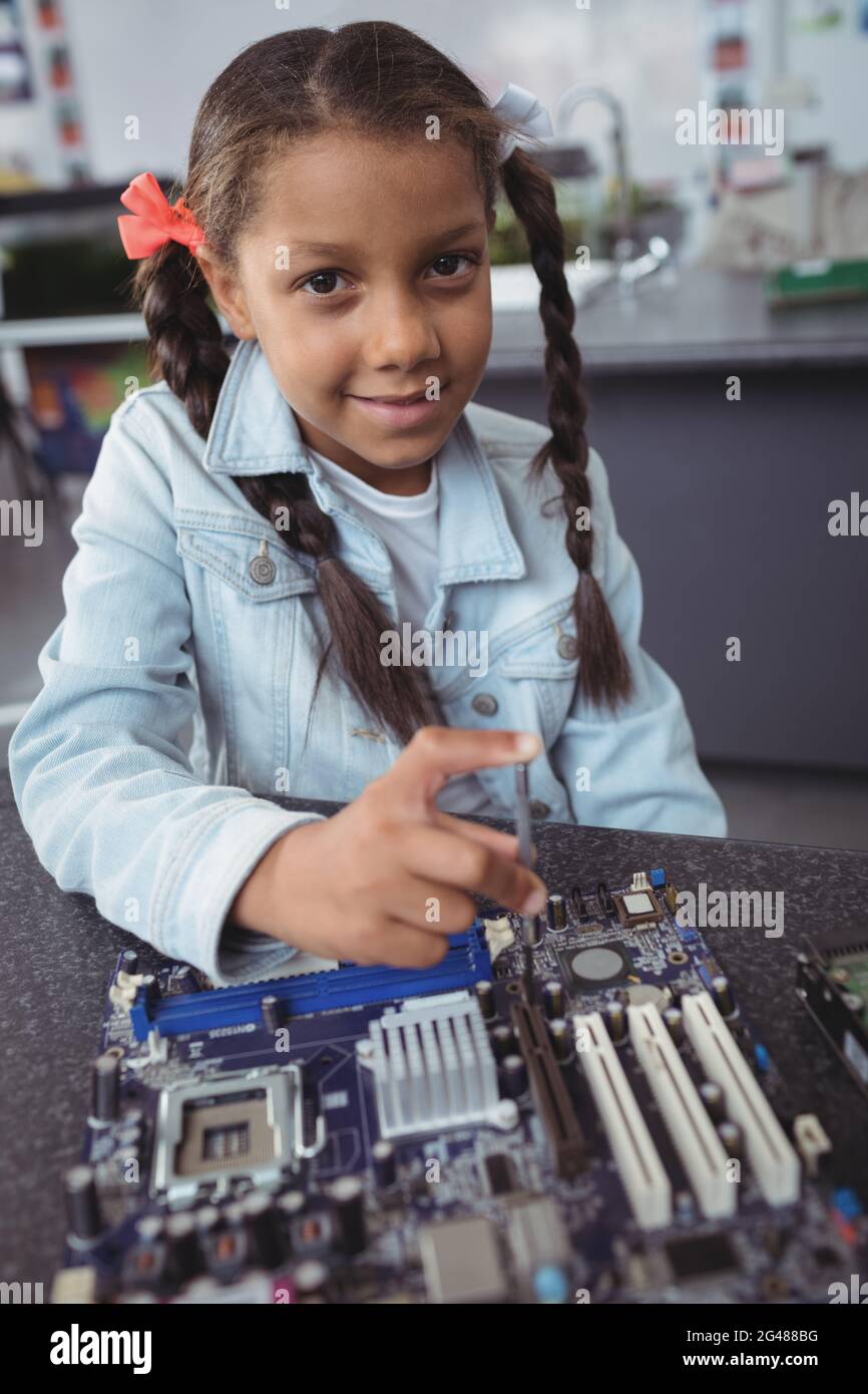 Portrait of elementary girl assembling circuit board Stock Photo - Alamy
