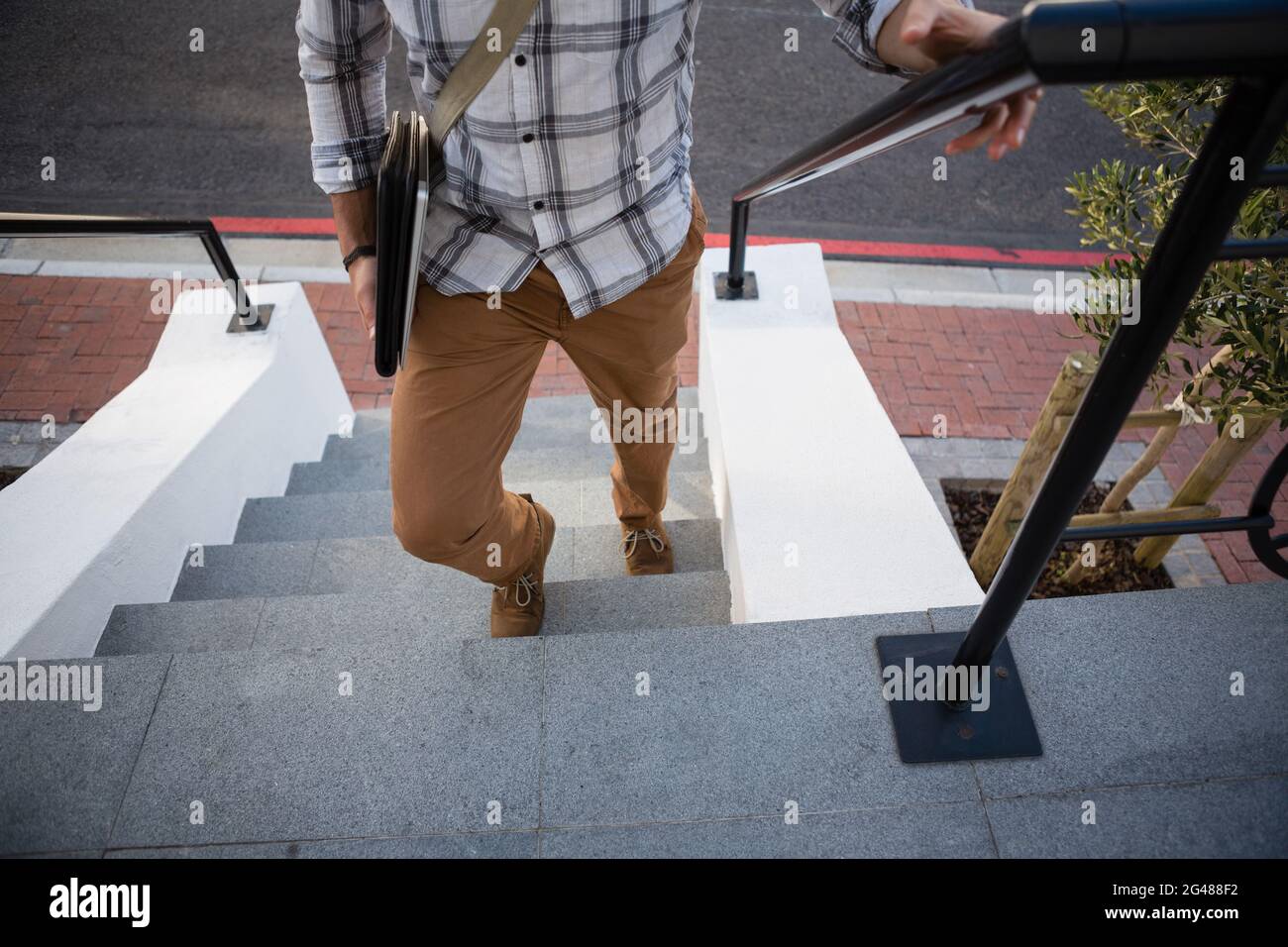 Man moving up on steps Stock Photo - Alamy