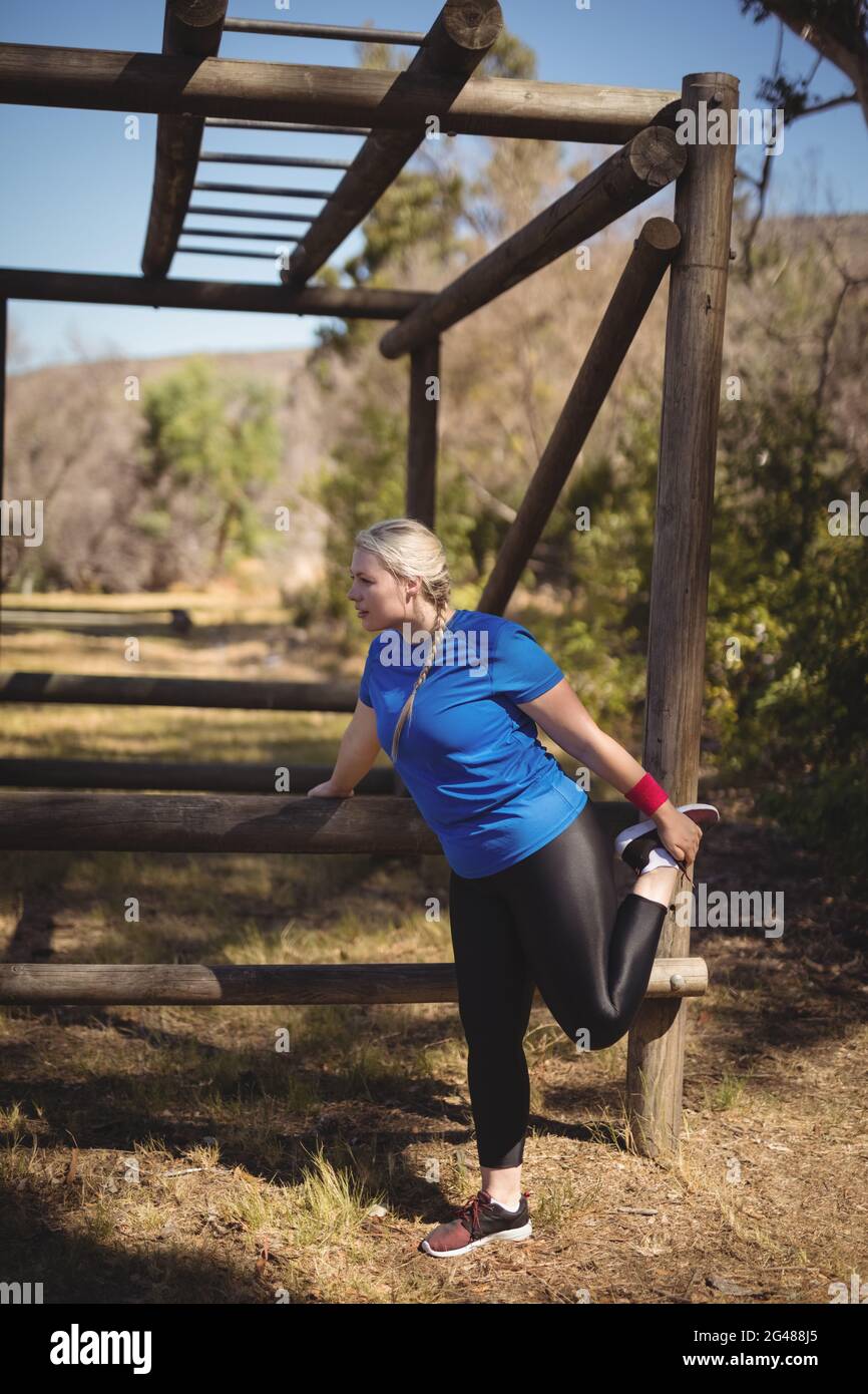 Beautiful woman exercising during obstacle course Stock Photo - Alamy