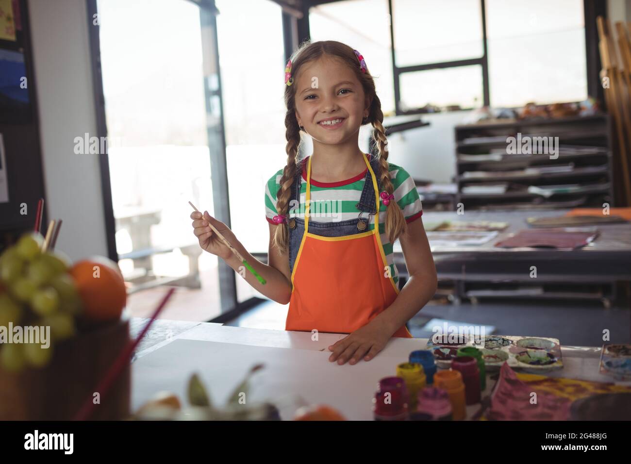 Portrait of smiling girl at painting class Stock Photo - Alamy