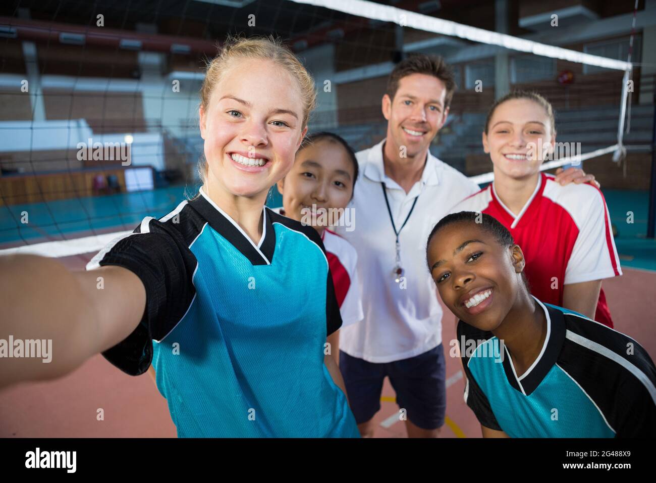 Male coach and volleyball players taking selfie Stock Photo - Alamy