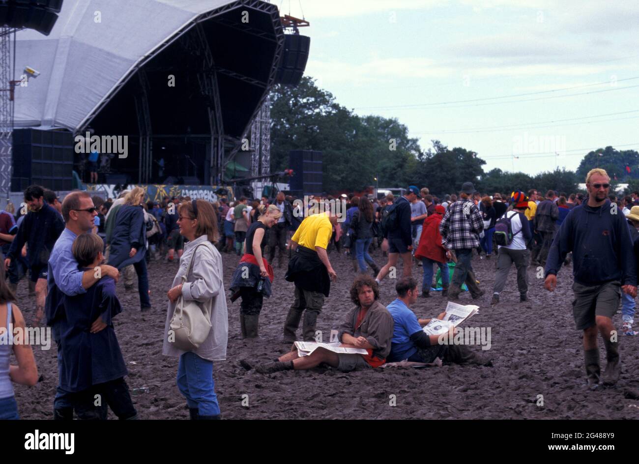 Two men seating on mud reading a newspaper hi-res stock photography and ...