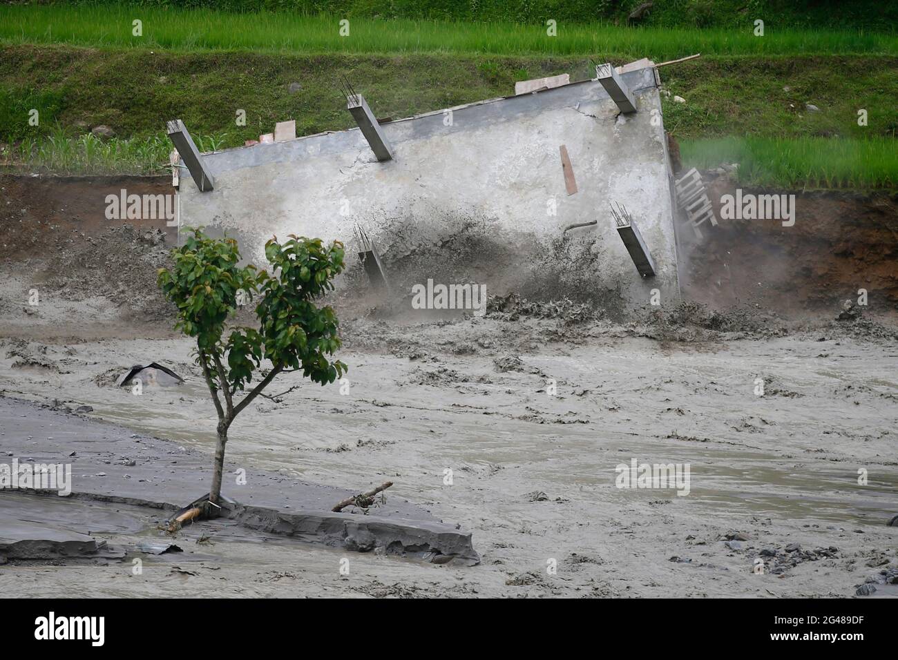 Helambu, Nepal. 19th June, 2021. A building is swept away by a flood ...