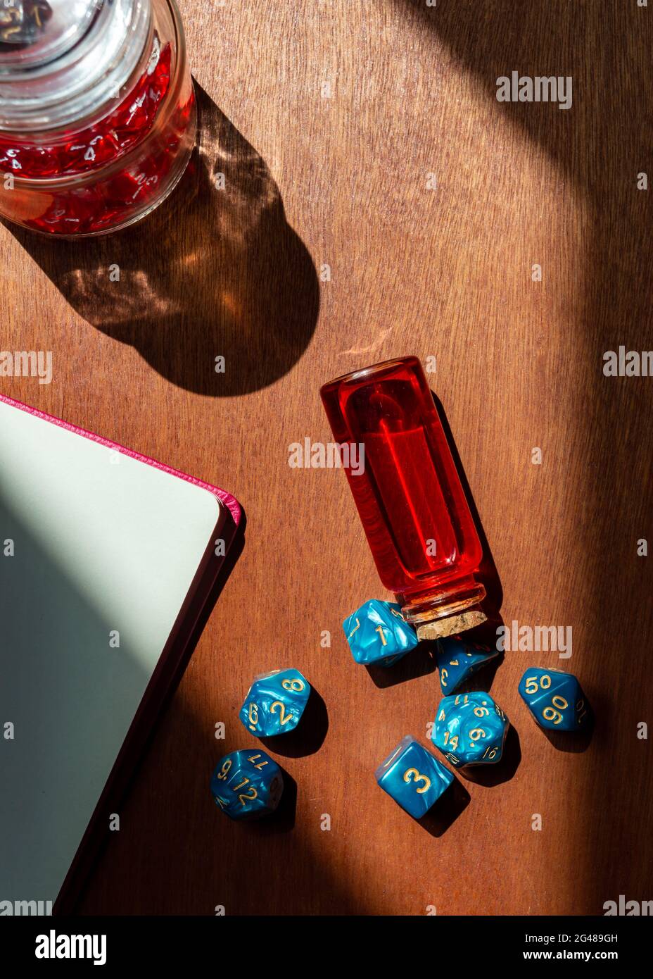 Vertical overhead image of a set of blue marbled role-playing dice, a ...