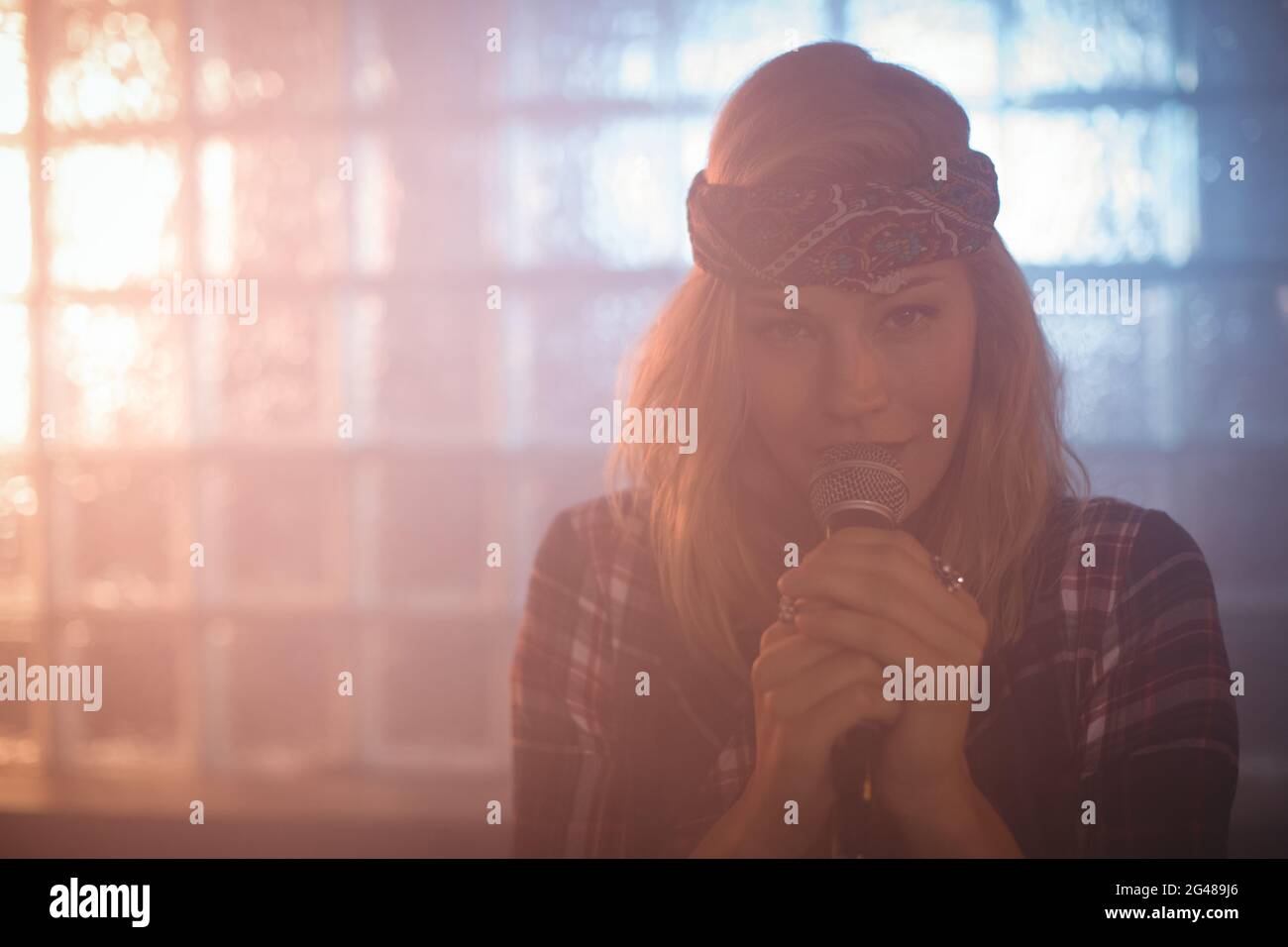 Portrait of beautiful female singer performing in music concert Stock ...
