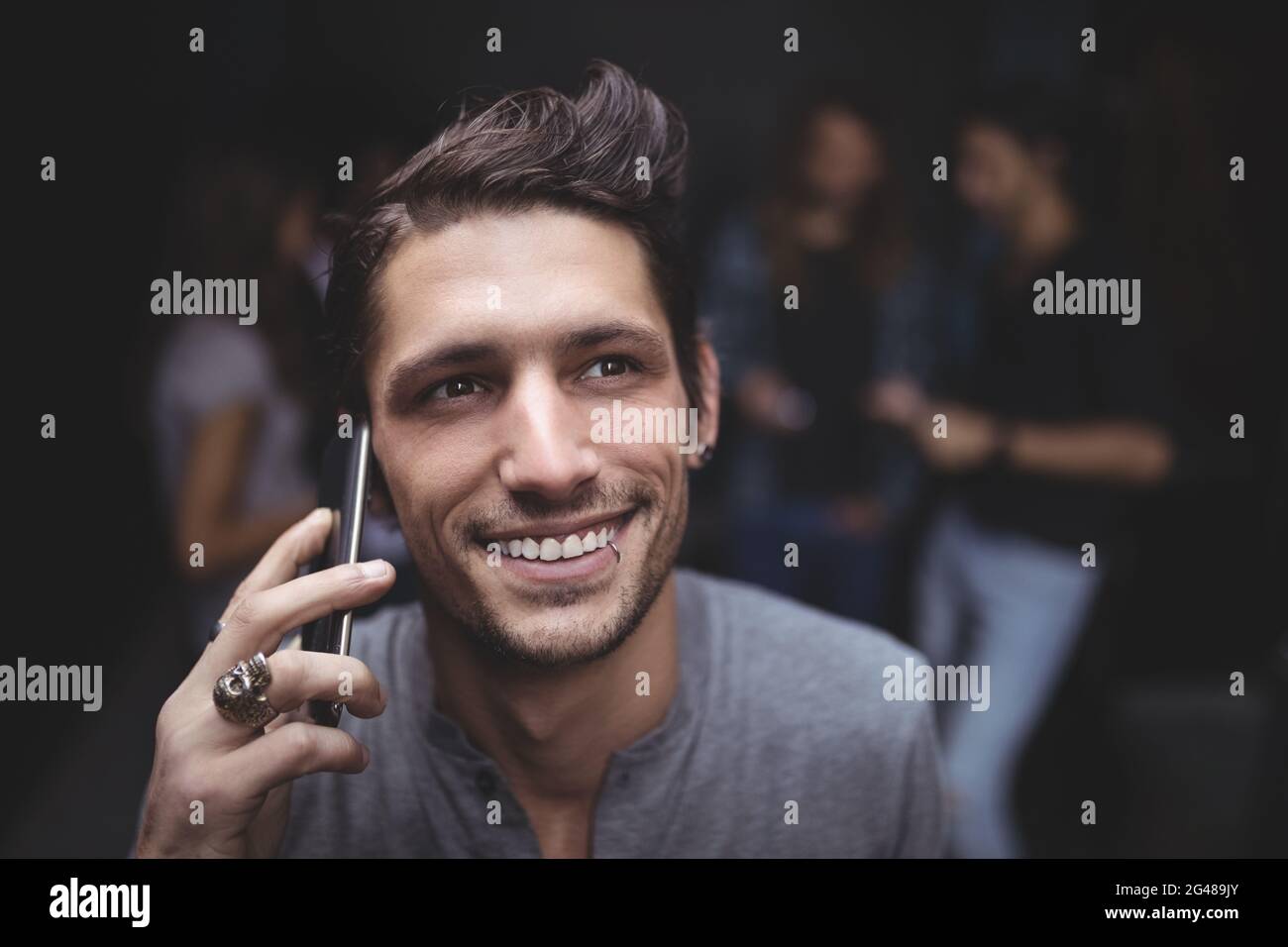High angle view of young man talking on mobile phone Stock Photo - Alamy