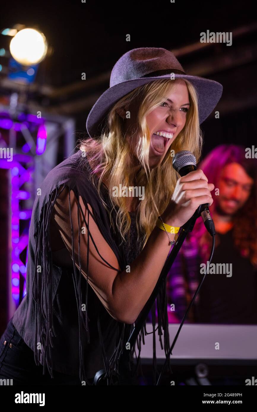Singer performing on stage Stock Photo - Alamy