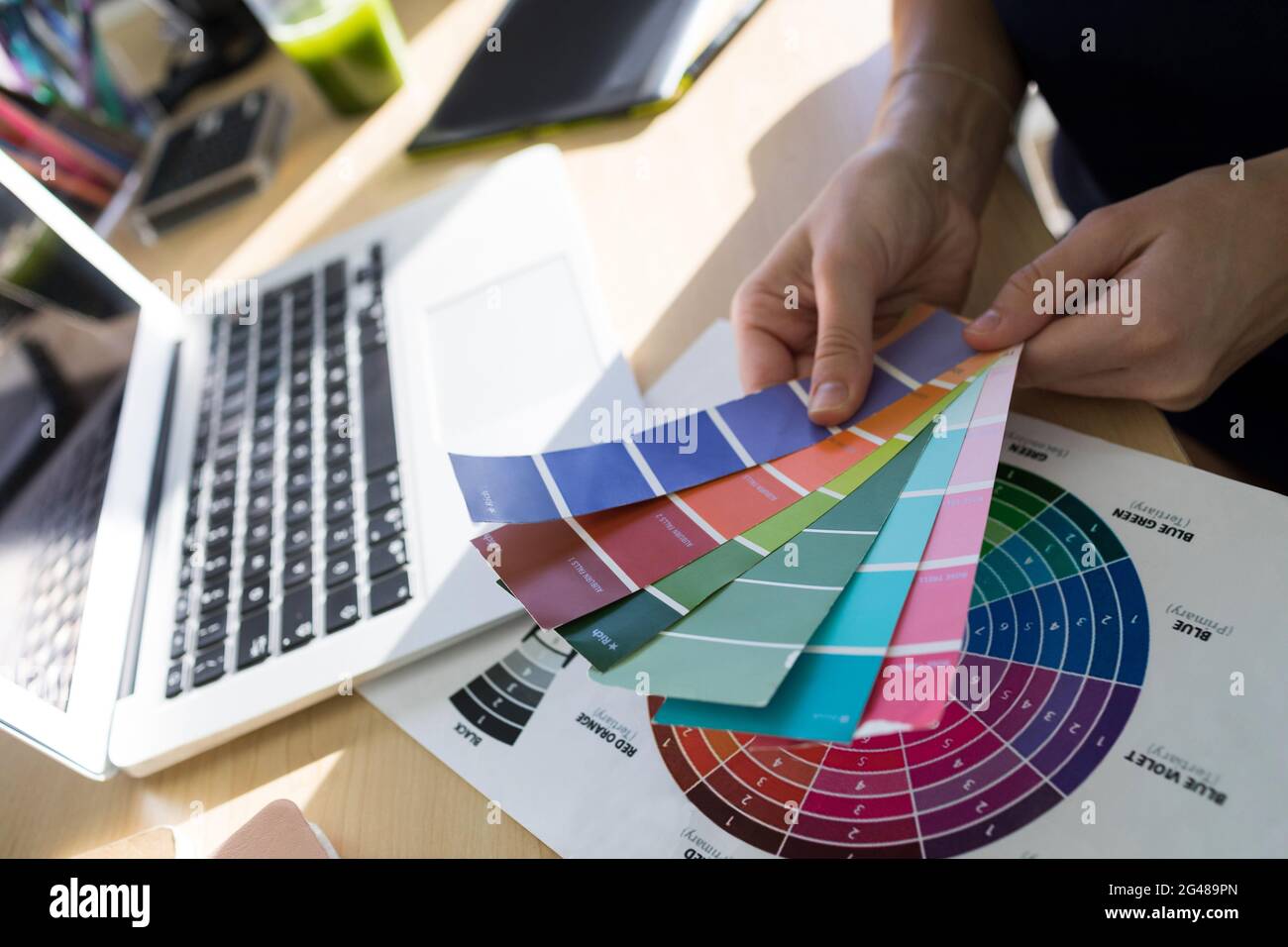 Female executives holding color shade swatch at her desk Stock Photo ...
