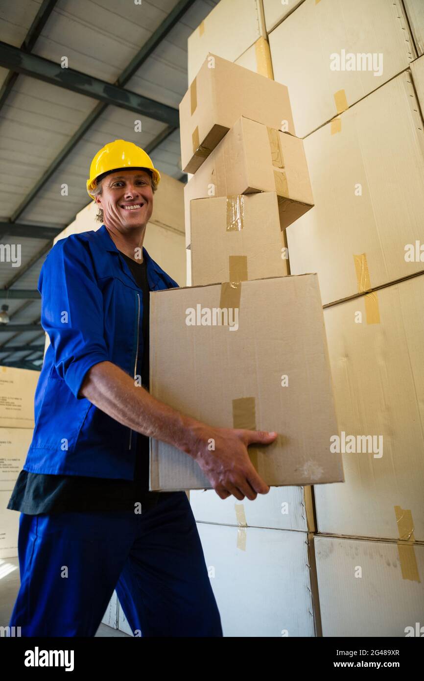 Worker holding a cardboard boxes while walking in olive factory Stock ...