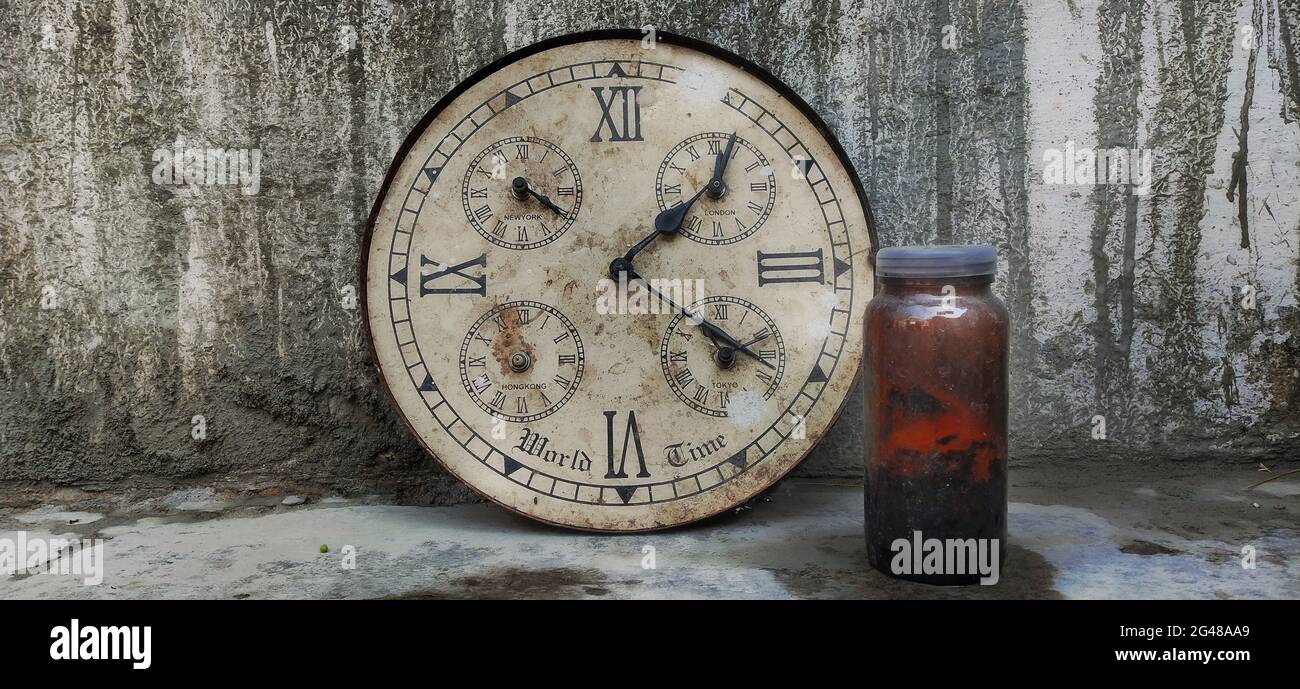 Old vintage clock by a grungy wall Stock Photo - Alamy