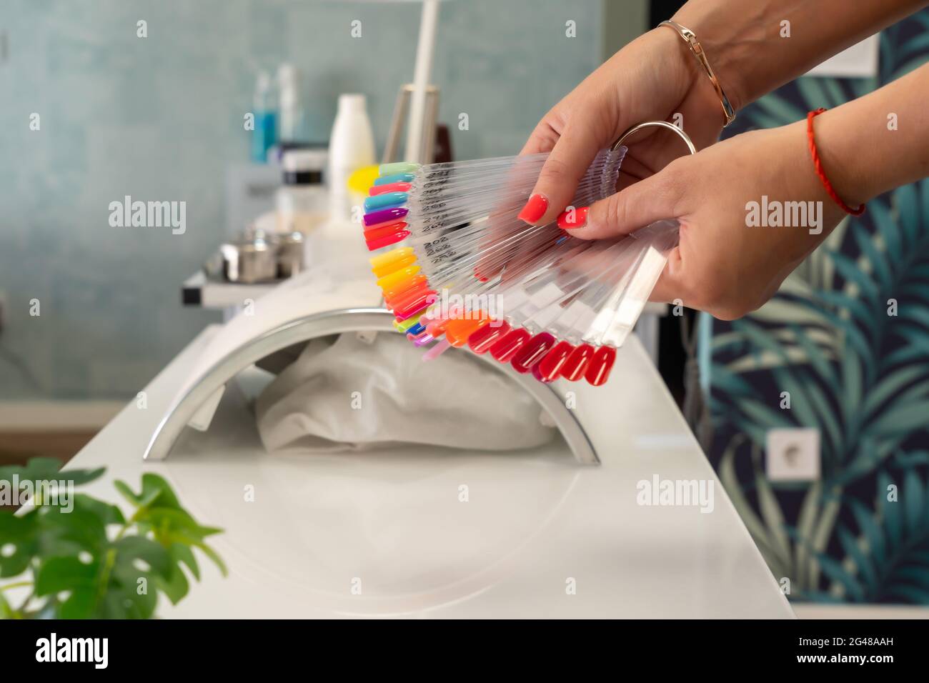 Female showing nail color options Stock Photo - Alamy