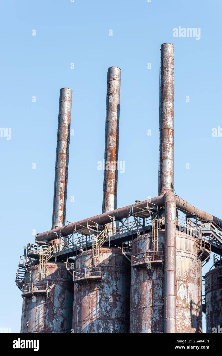 Obsolete steel factory with three smoke stacks Stock Photo - Alamy