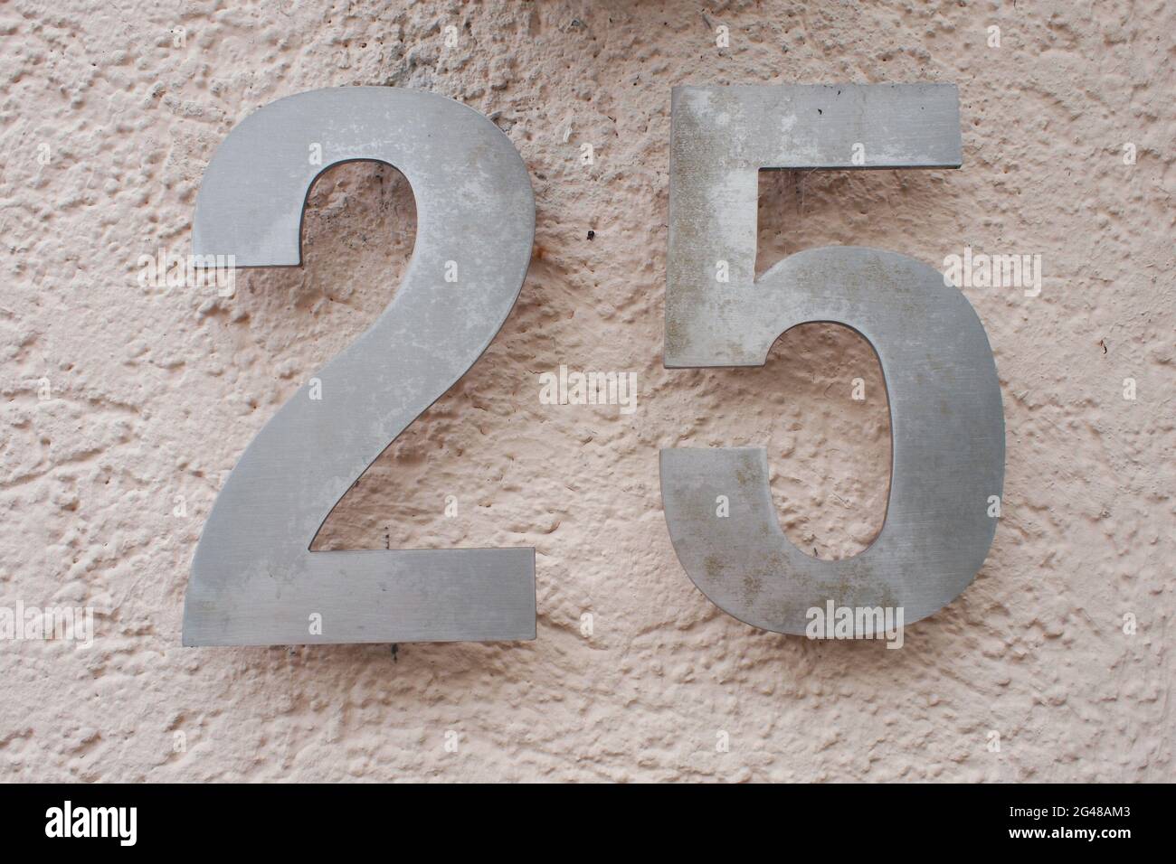 House number "25" attached to a wall Stock Photo - Alamy