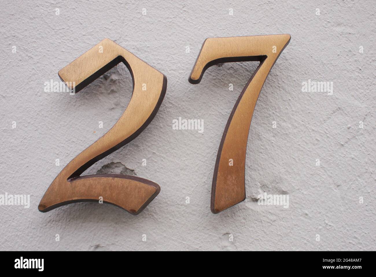 House number "27" attached to a wall Stock Photo - Alamy