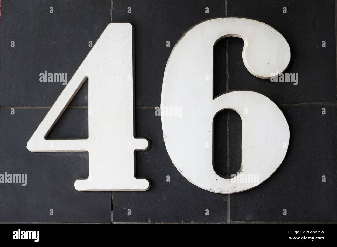 House number "46" attached to a wall Stock Photo - Alamy