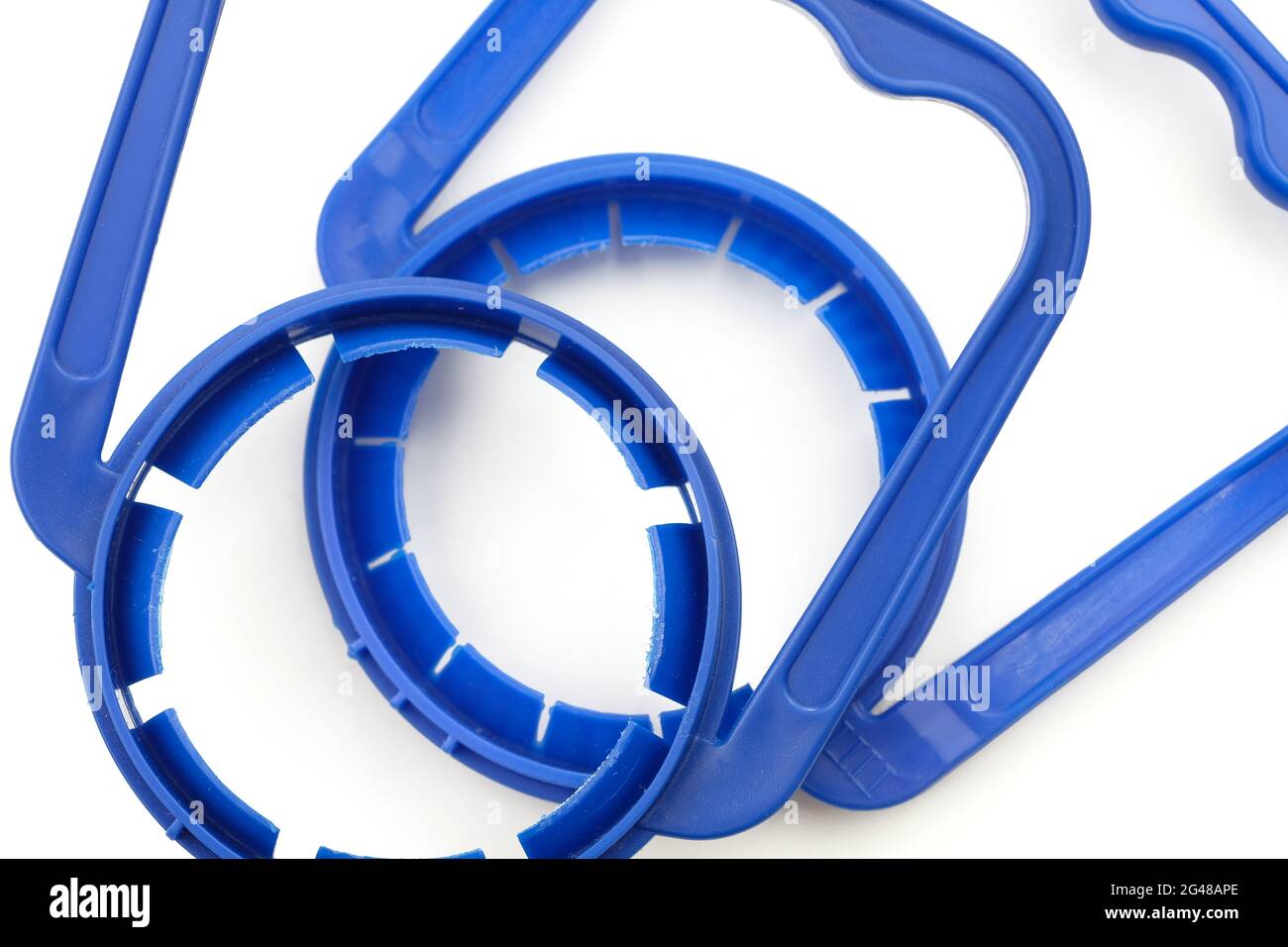 Plastic blue handles for bottles of large sizes on a white background ...