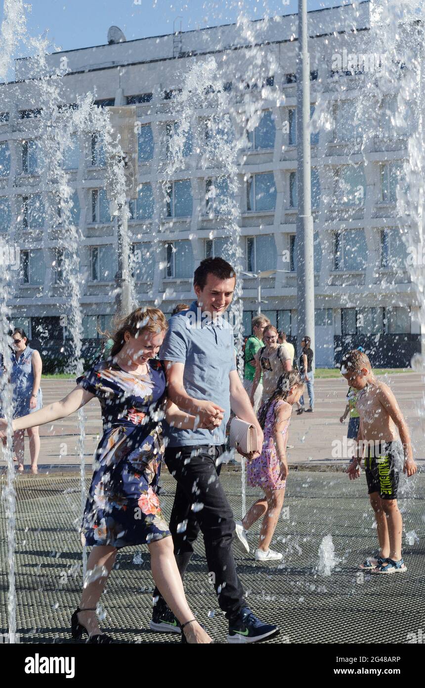 People refresh themselves in the heat in the city fountain. Russia ...