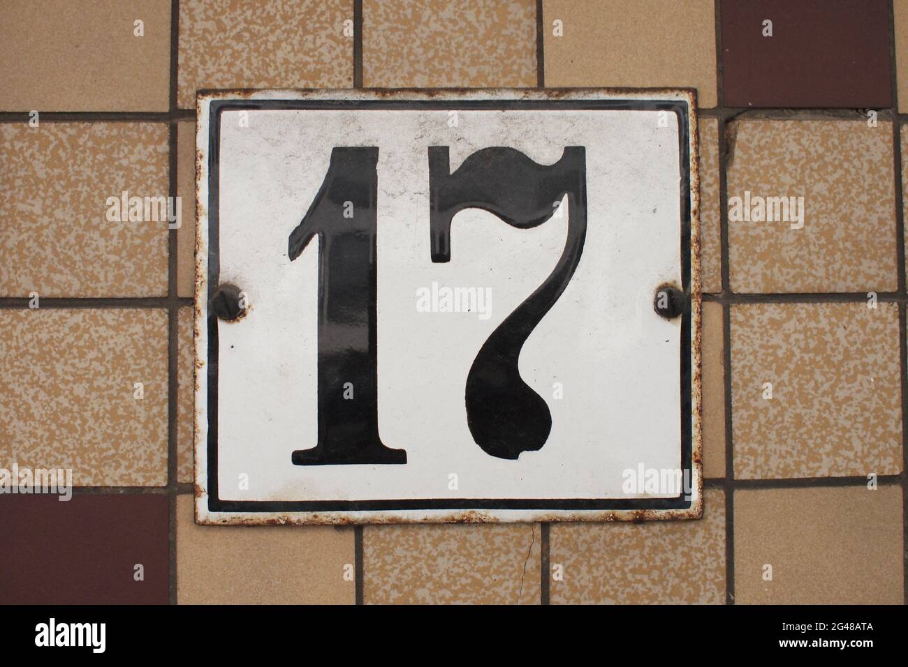 House number "17" attached to a brick wall Stock Photo - Alamy