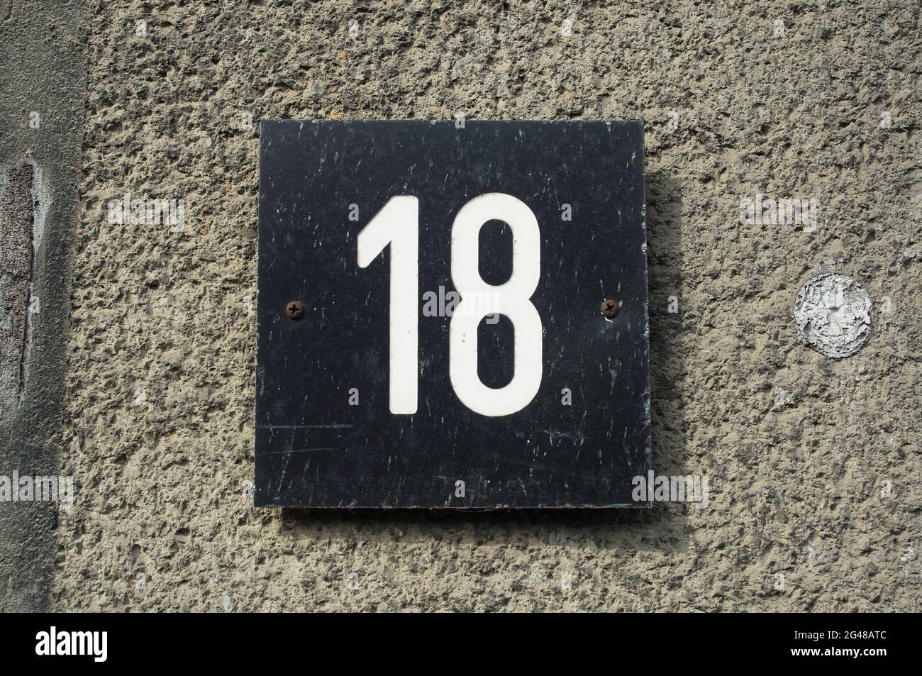 House number "18" attached to a wall Stock Photo - Alamy