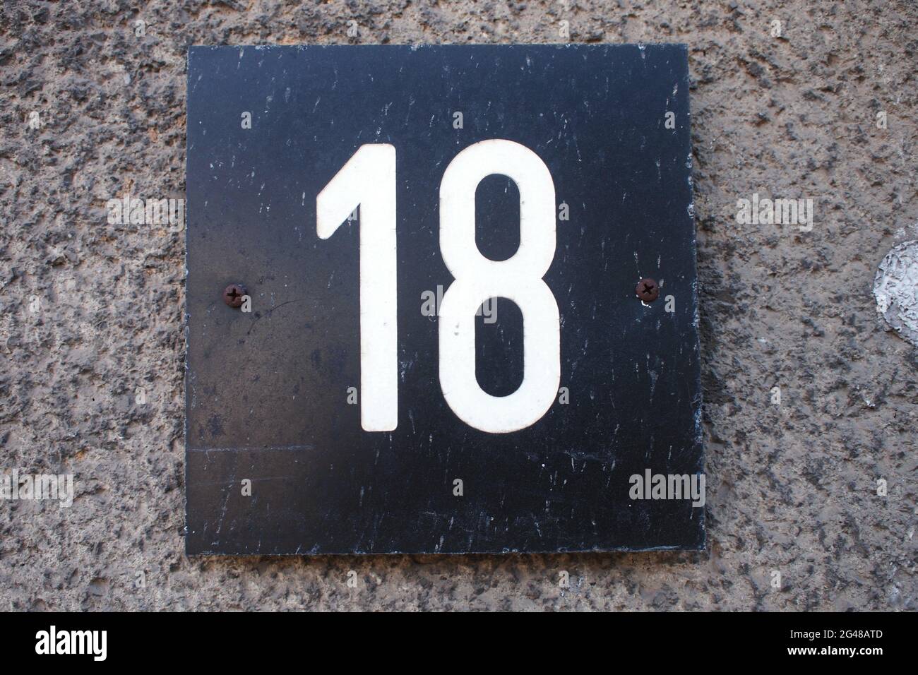 House number "18" attached to a wall Stock Photo - Alamy