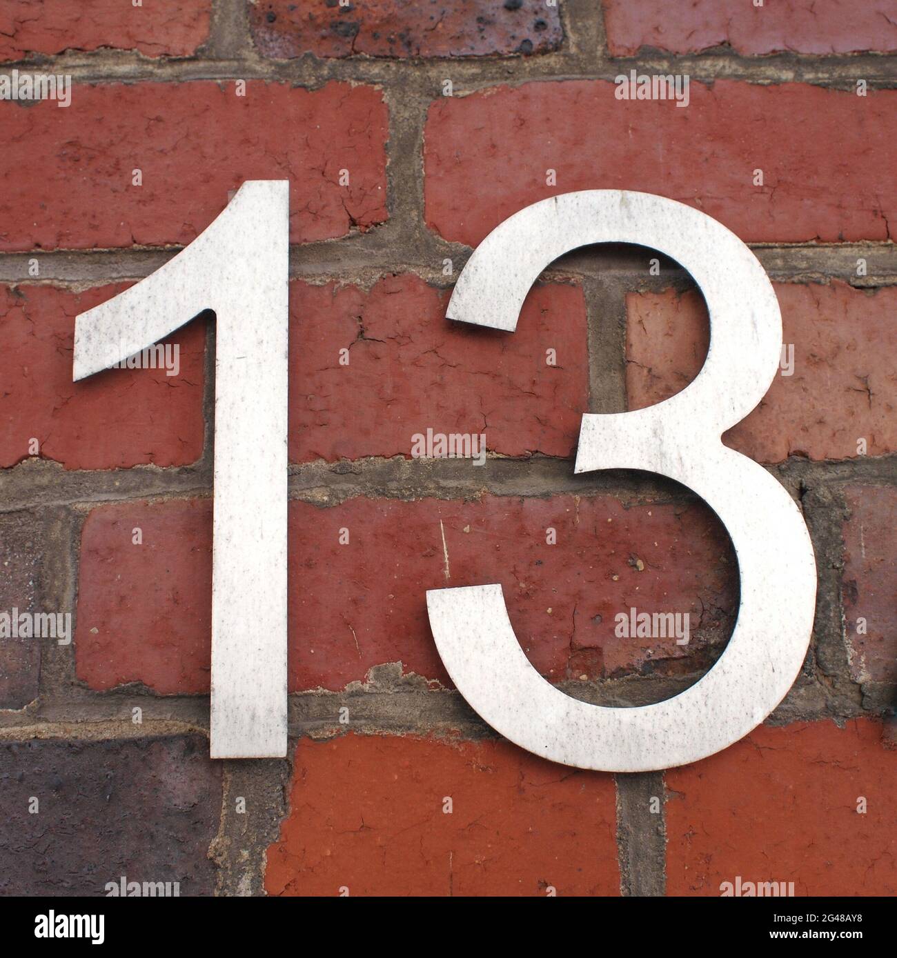 House number "1" attached to a brick wall Stock Photo - Alamy