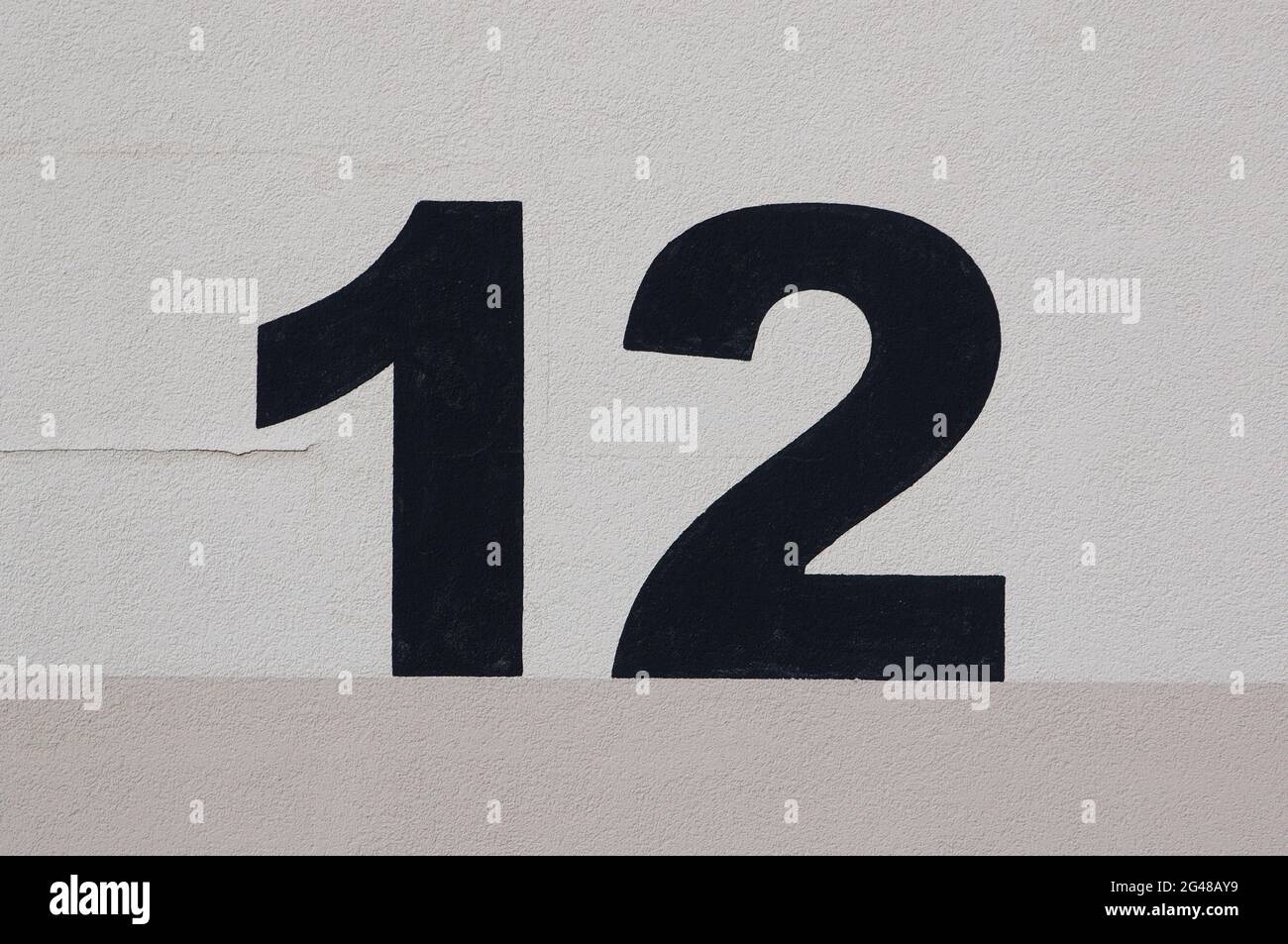 House number "12" painted on a wall Stock Photo - Alamy