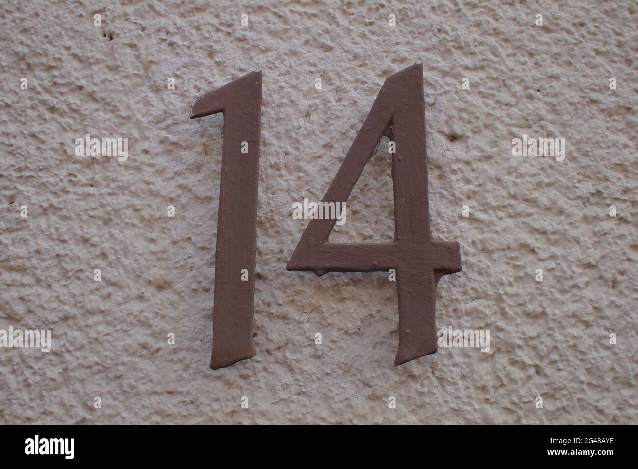 House number "14" attached to a wall Stock Photo - Alamy