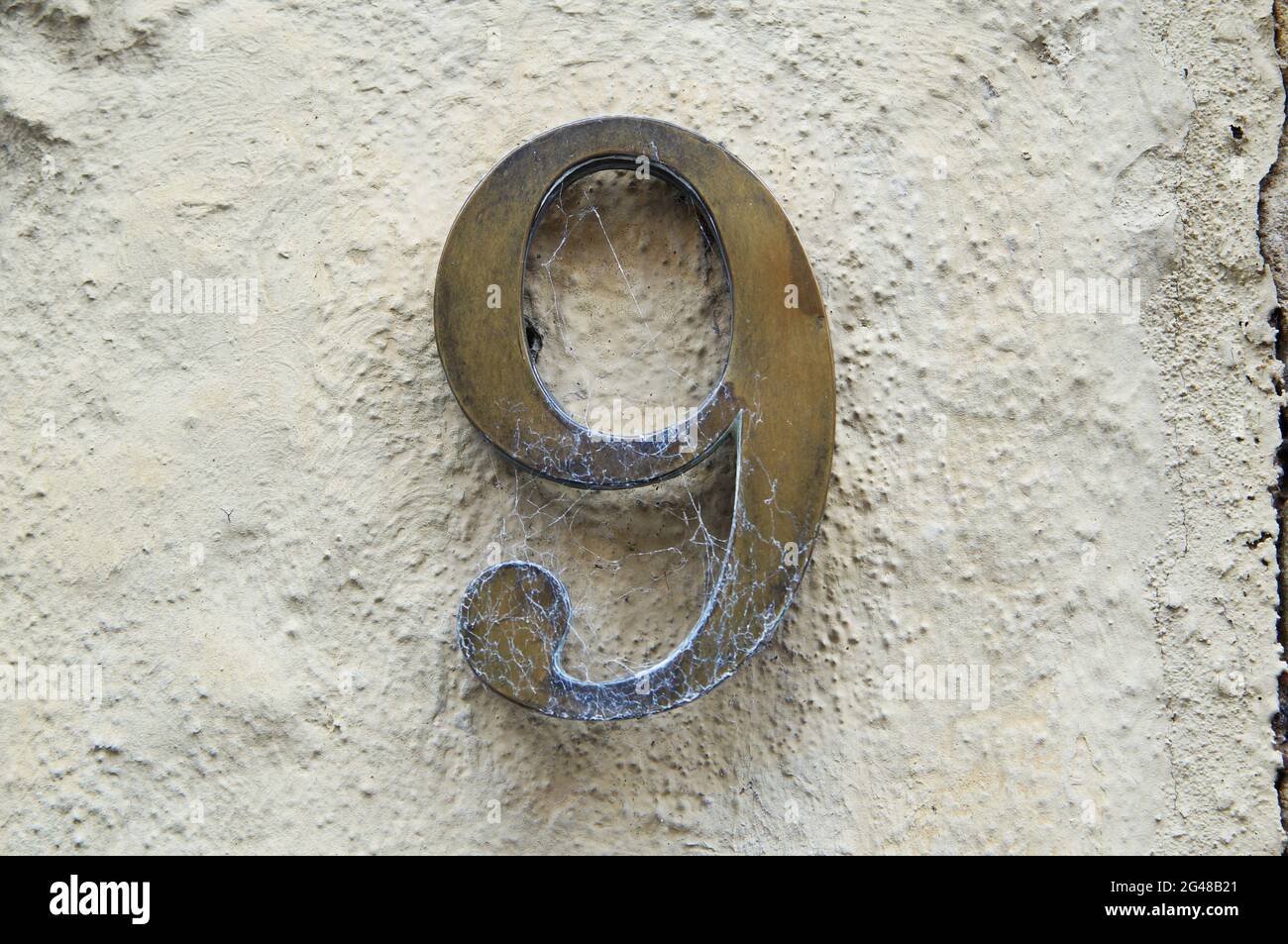 House number "9" attached to a wall Stock Photo - Alamy