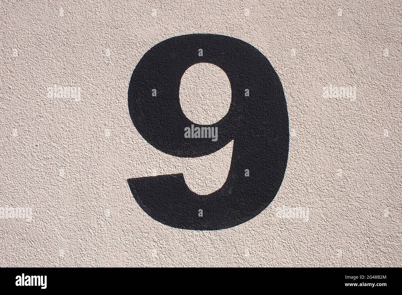 House number "9" painted on a wall Stock Photo - Alamy