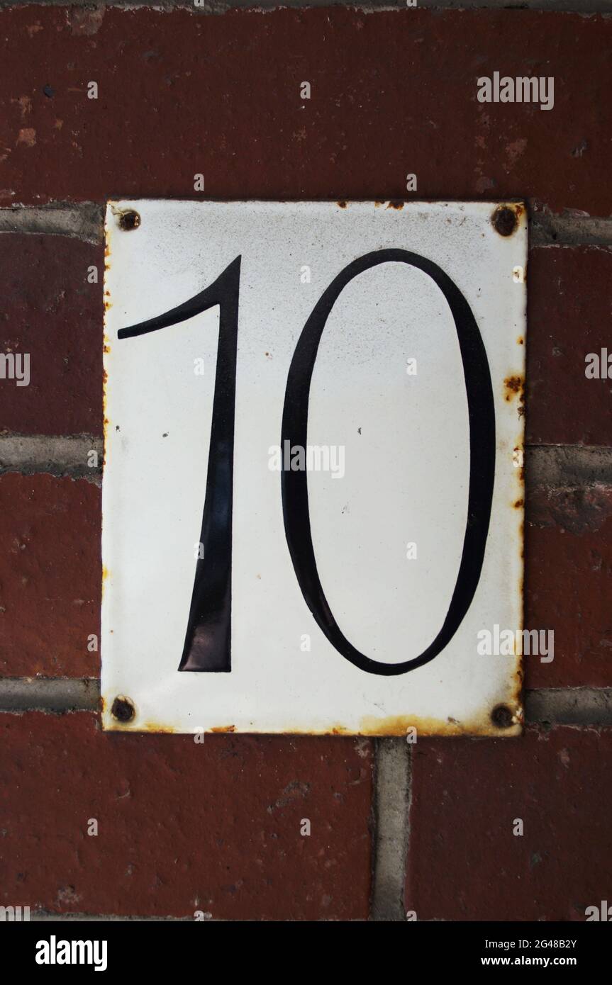 House number "10" attached to a brick wall Stock Photo - Alamy