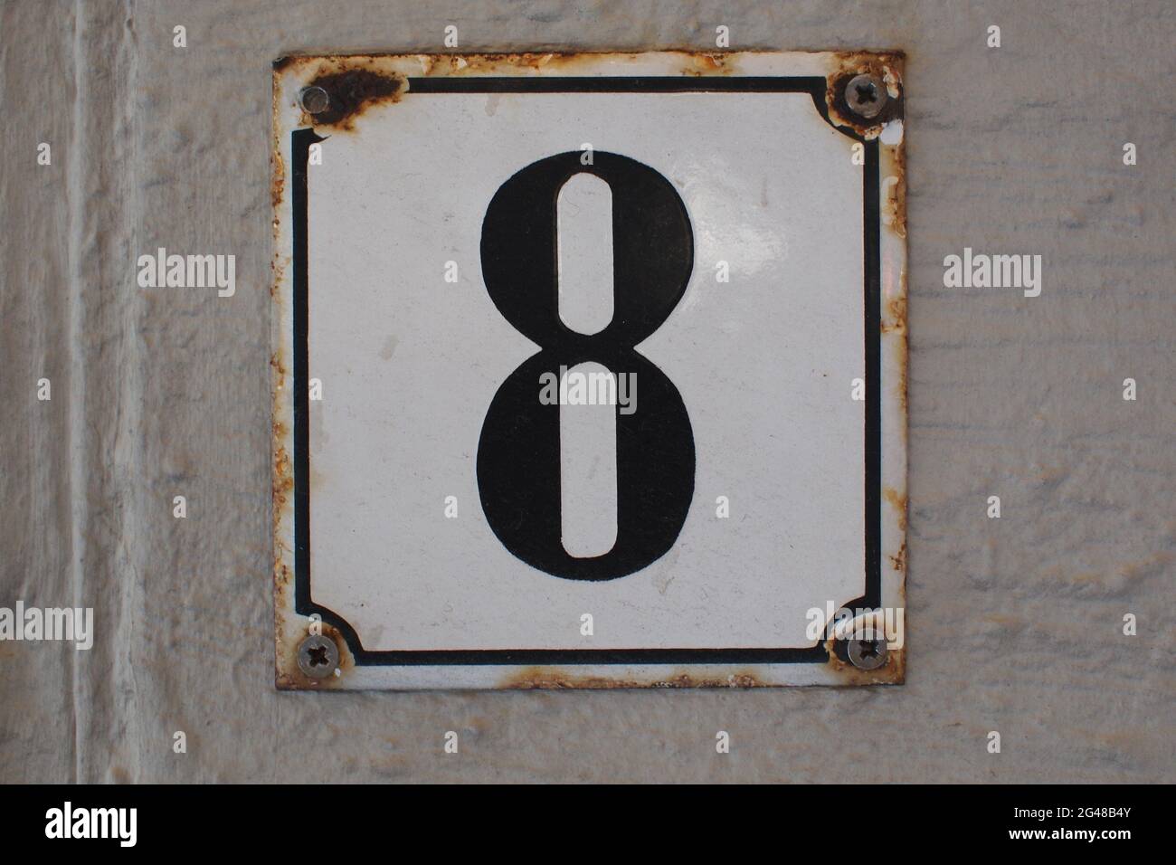 House number "8" attached to a wall Stock Photo - Alamy