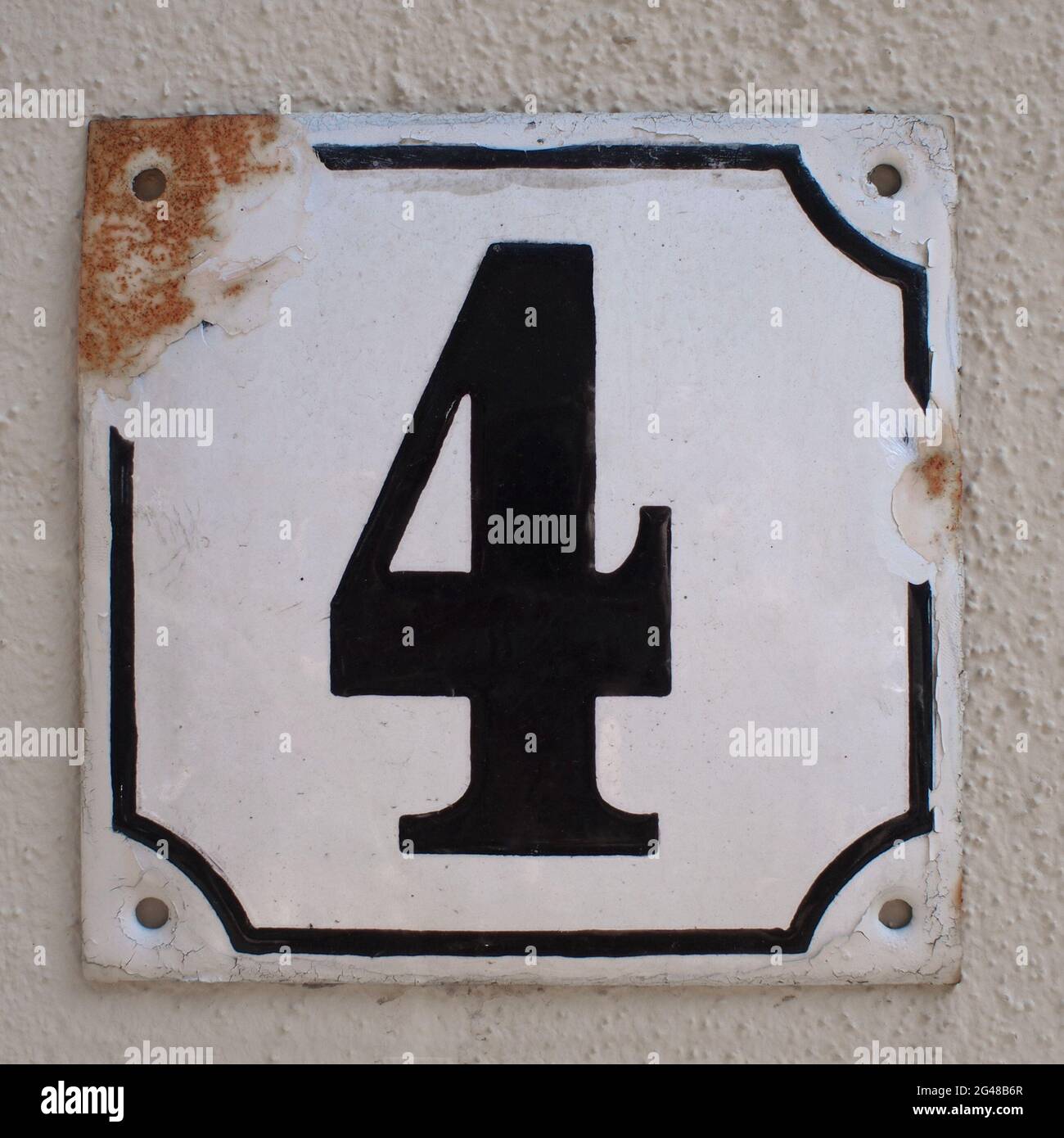 House number "4" attached to a wall Stock Photo - Alamy