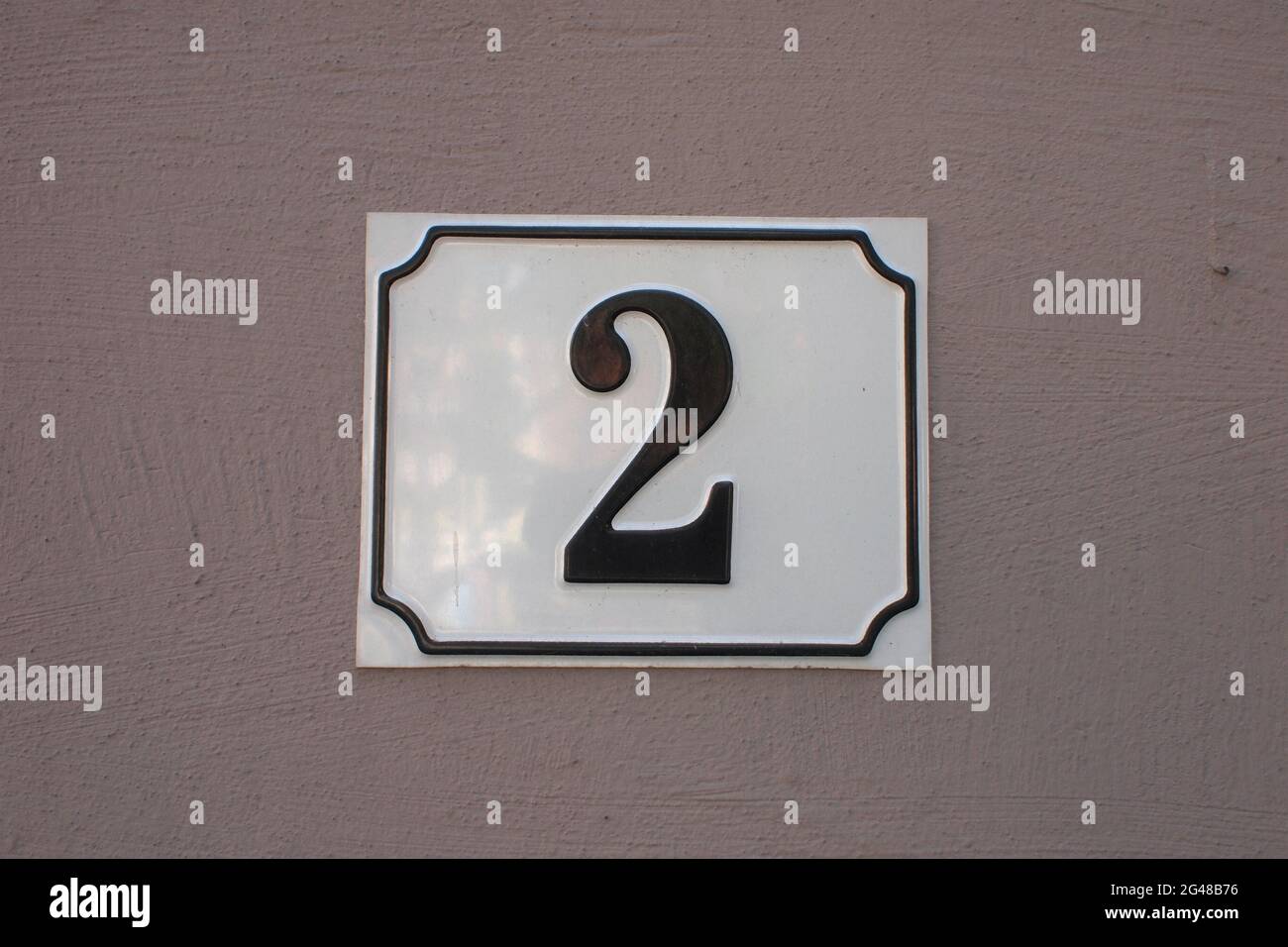 House number "2" attached to a wall Stock Photo - Alamy