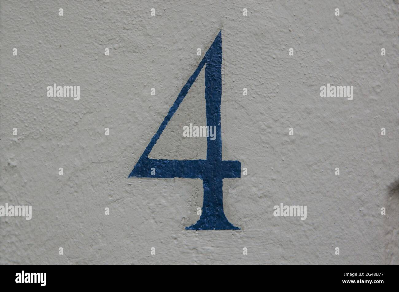 House number "4" painted on a wall Stock Photo - Alamy
