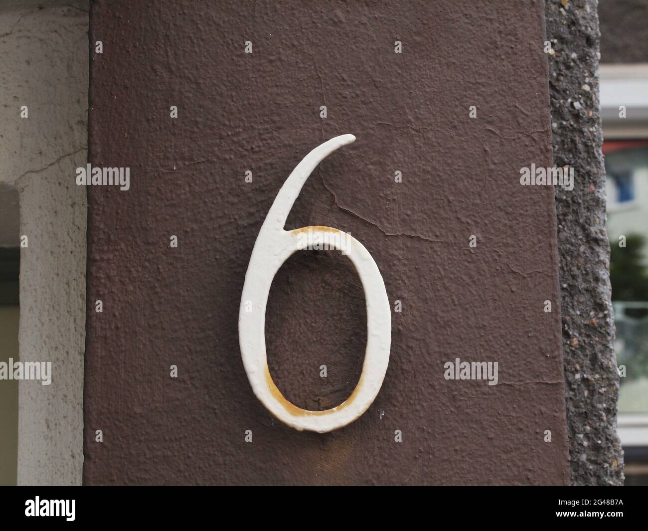 House number "6" attached to a wall Stock Photo - Alamy