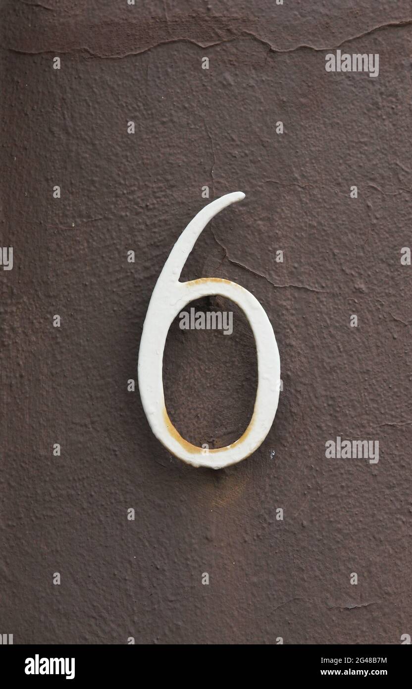 House number "6" attached to a wall Stock Photo - Alamy