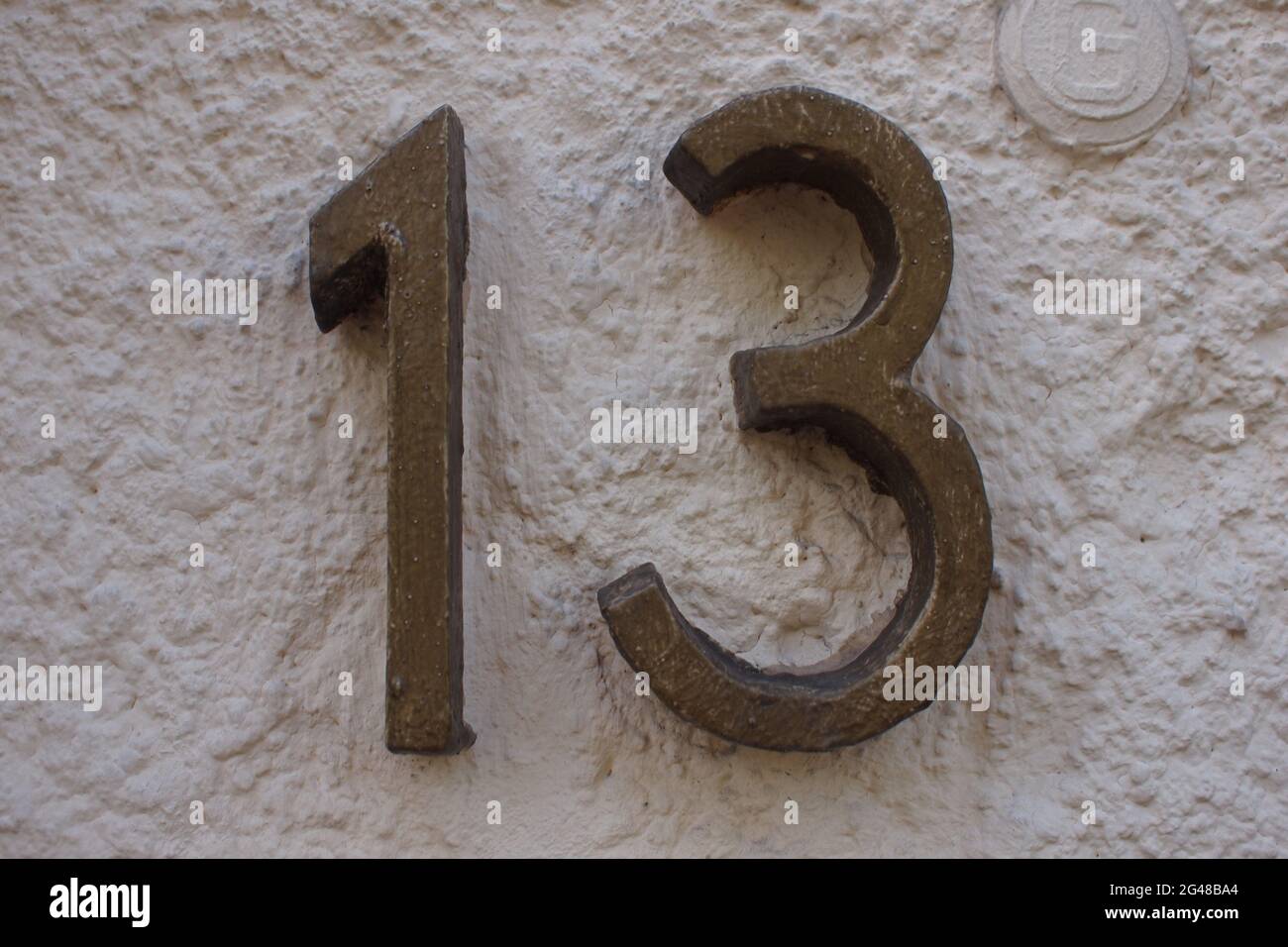 House number "13" attached to a wall Stock Photo - Alamy