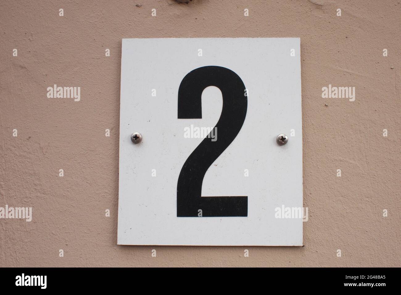 House number "2" attached to a wall Stock Photo - Alamy