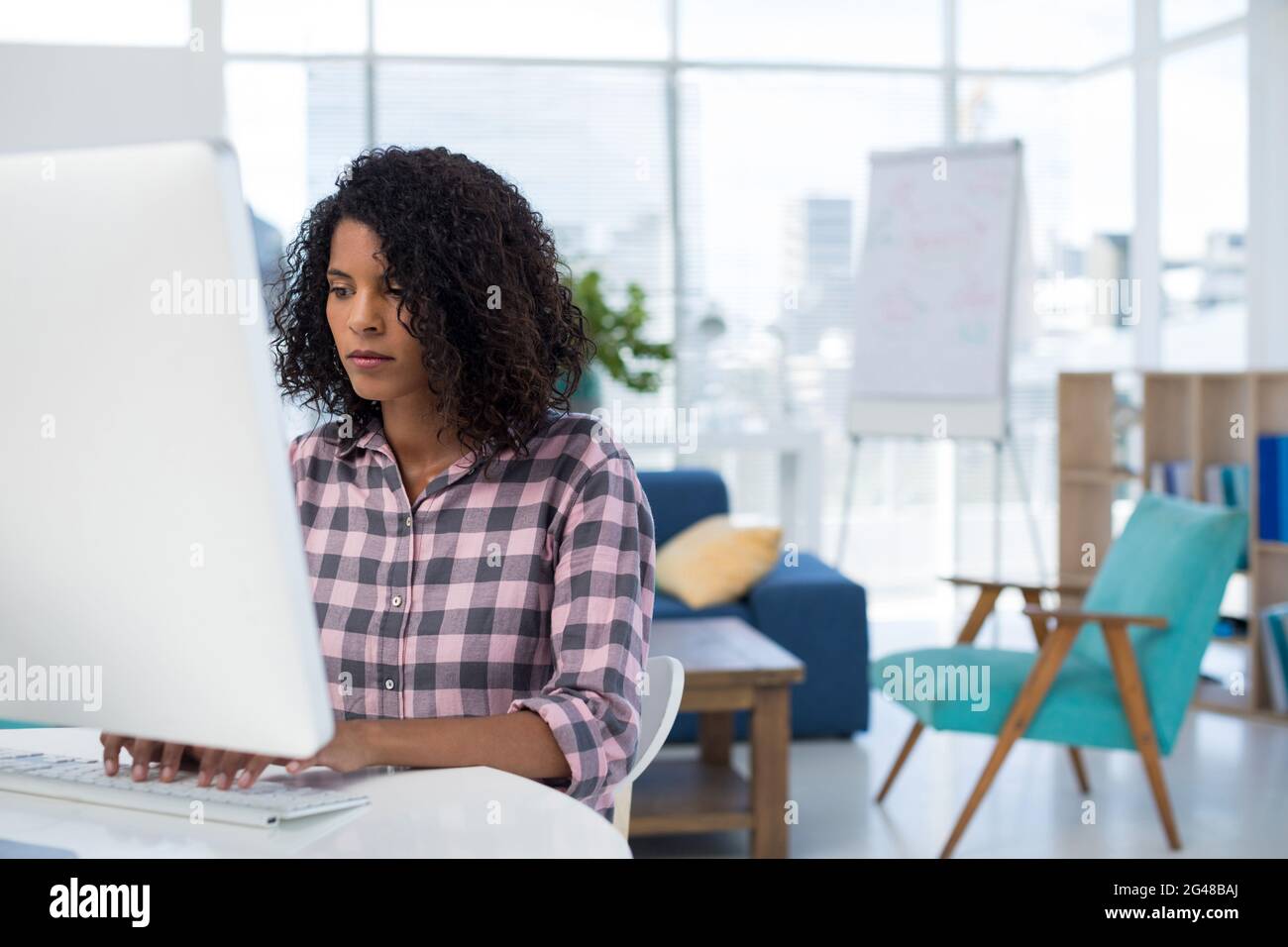 Female executive working on computer at desk Stock Photo - Alamy