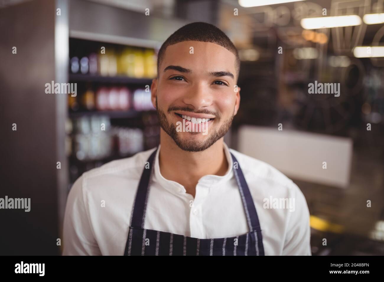 Smiling handsome young waiter hi-res stock photography and images - Alamy
