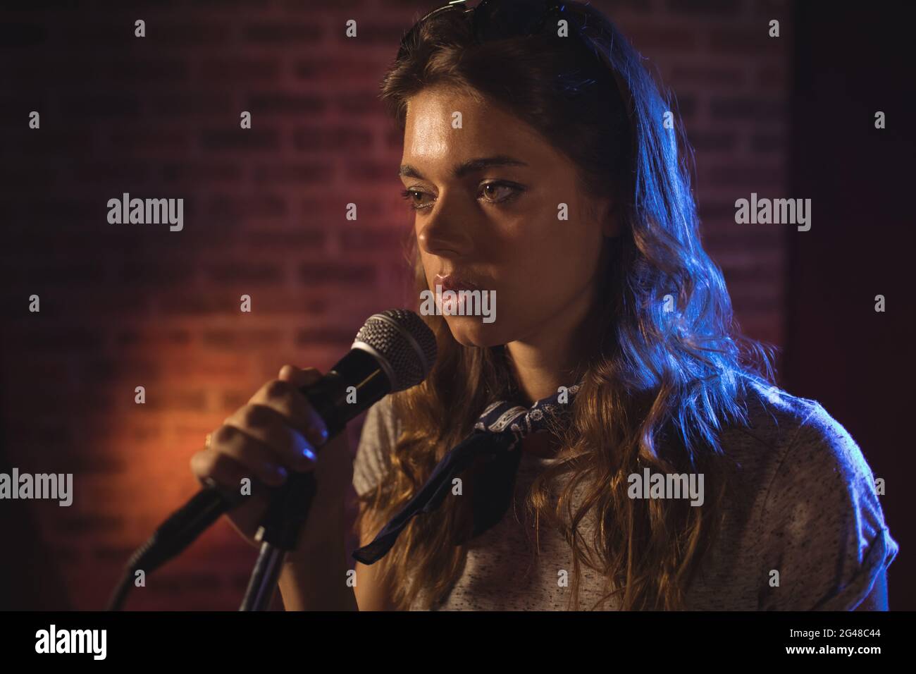 Female singer performing in music concert Stock Photo - Alamy